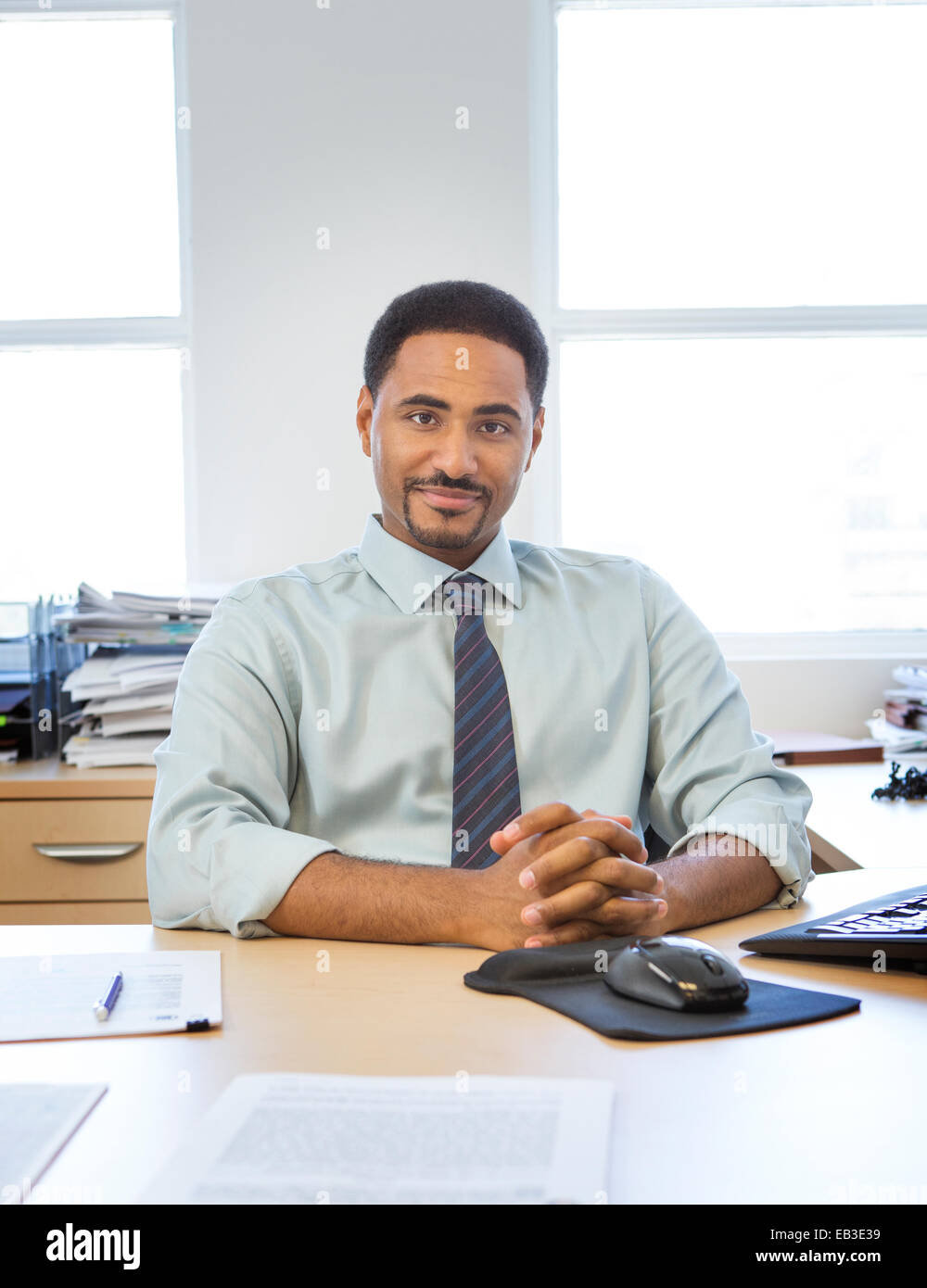 Portrait businessman sitting desk hi-res stock photography and images ...
