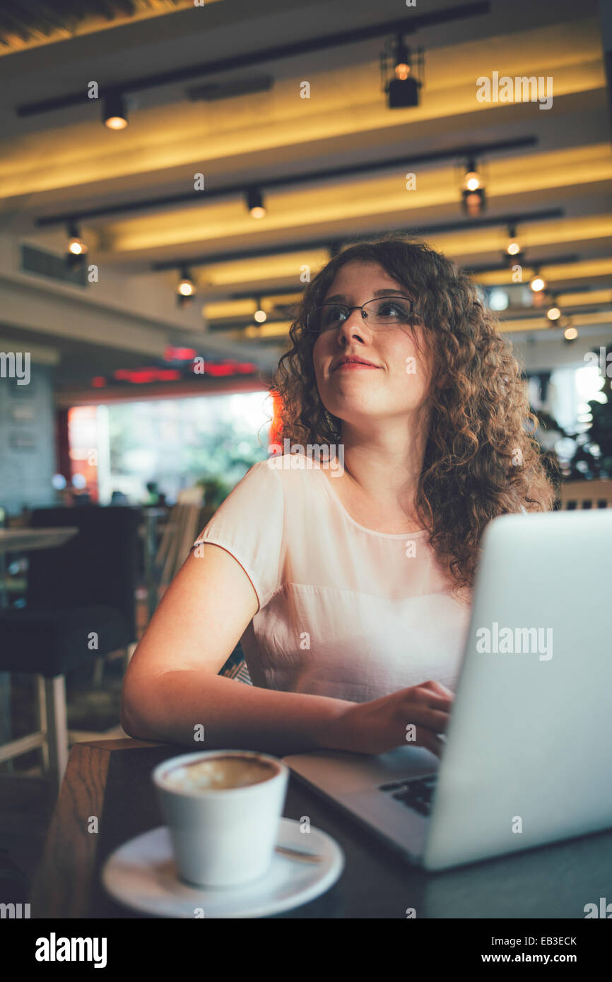 Woman using laptop computer in cafe Stock Photo - Alamy