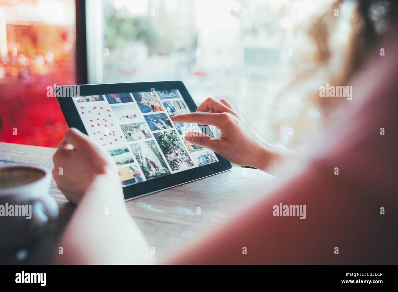 Woman using tablet computer in cafe Stock Photo - Alamy