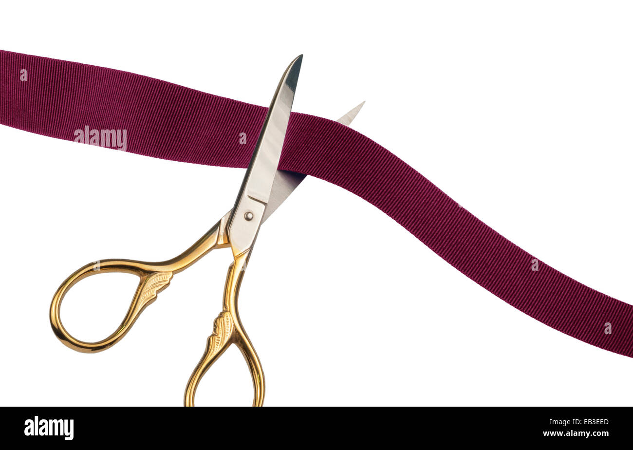 Scissors cutting a red ribbon Stock Photo - Alamy