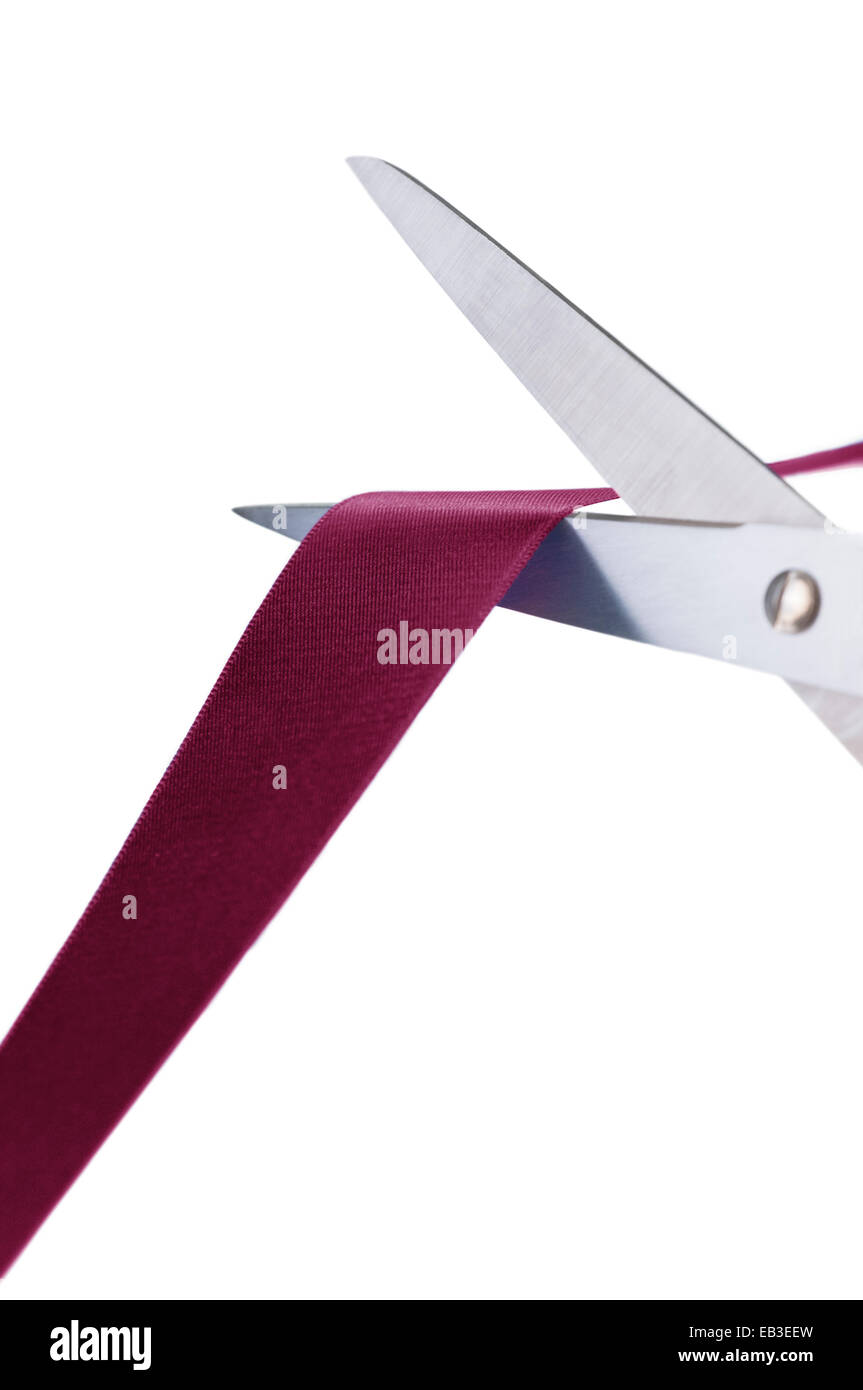 Scissors cutting a red ribbon Stock Photo - Alamy