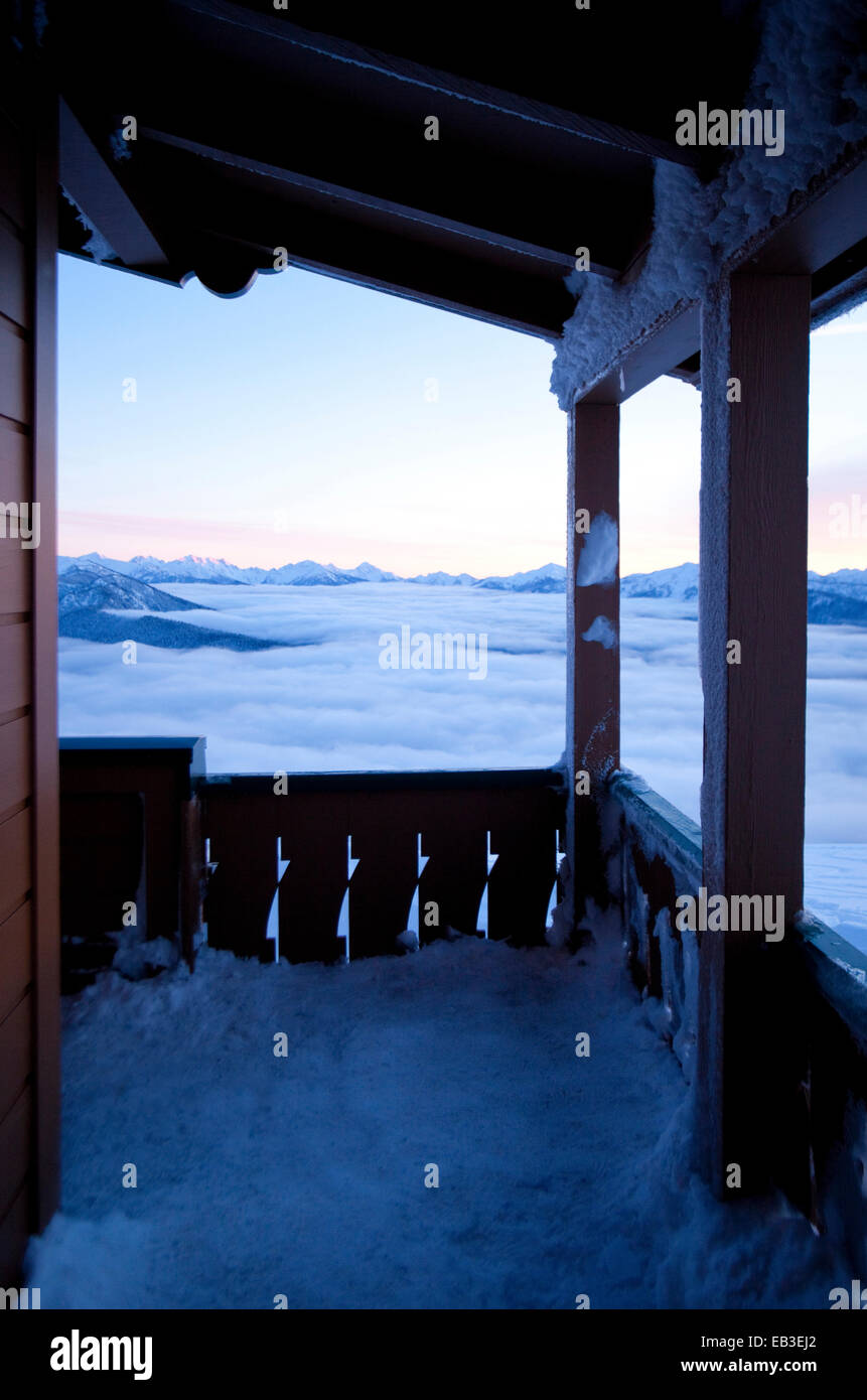 Snow covered porch overlooking remote landscape Stock Photo - Alamy