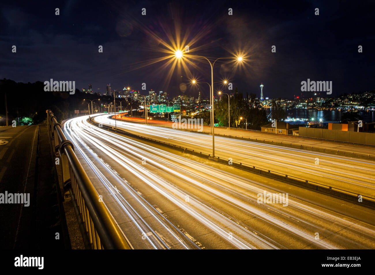 Long exposure of traffic on urban highway and city skyline at night ...