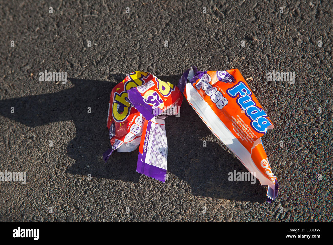 Discarded chocolate bar wrappers on a station platform Stock Photo - Alamy