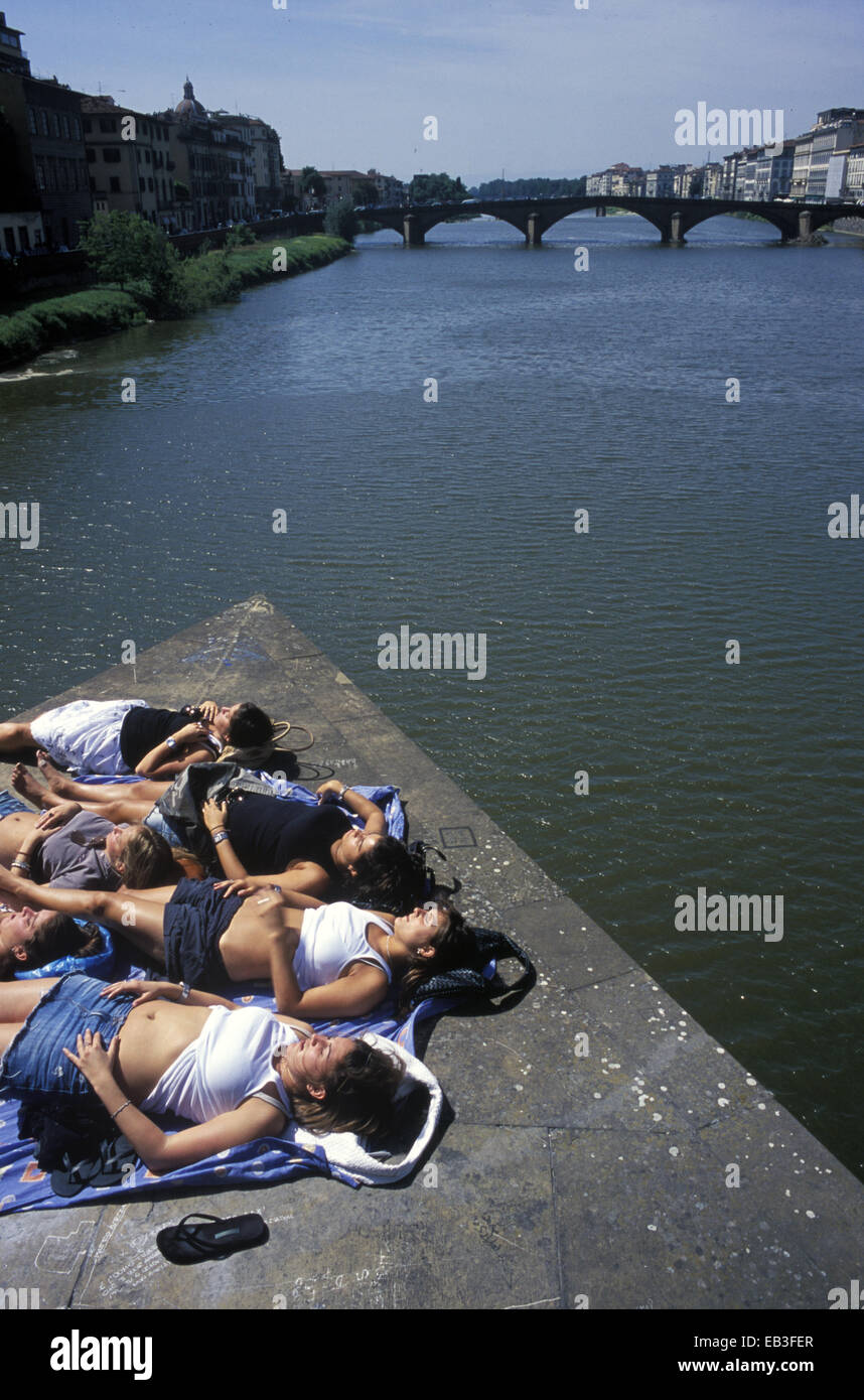 A group of girls sunbathing on one of the bridges over Arno river Stock ...