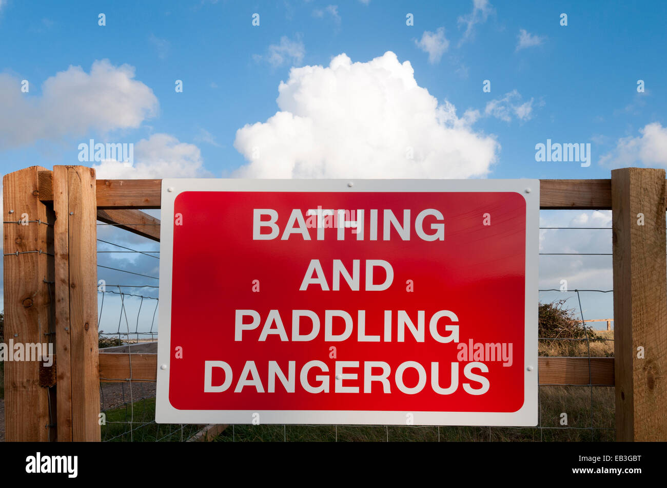 Bathing and paddling dangerous sign by the beach Stock Photo - Alamy