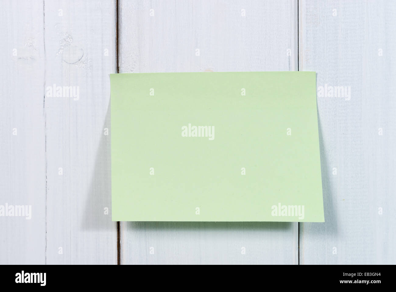 Note paper stick on wood background Stock Photo - Alamy