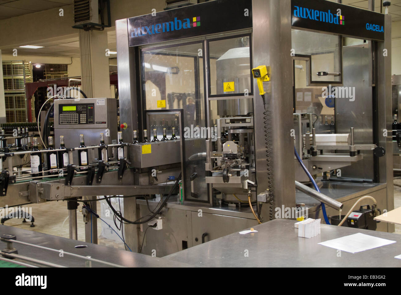 Wine bottles being filled by an automated filling machine Stock Photo ...