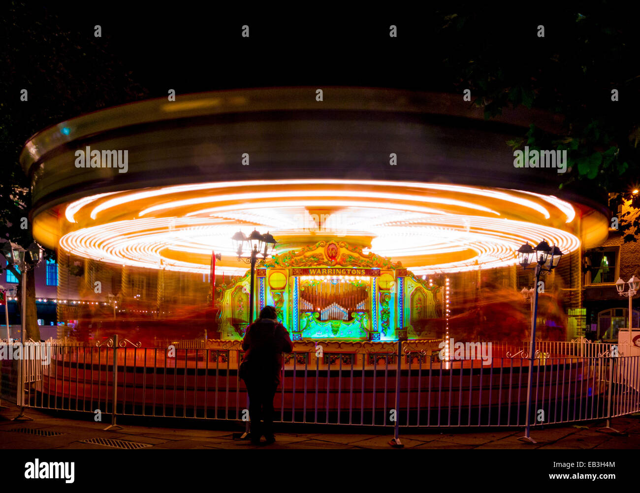 Victorian style carousel spinning with single person watching Stock ...