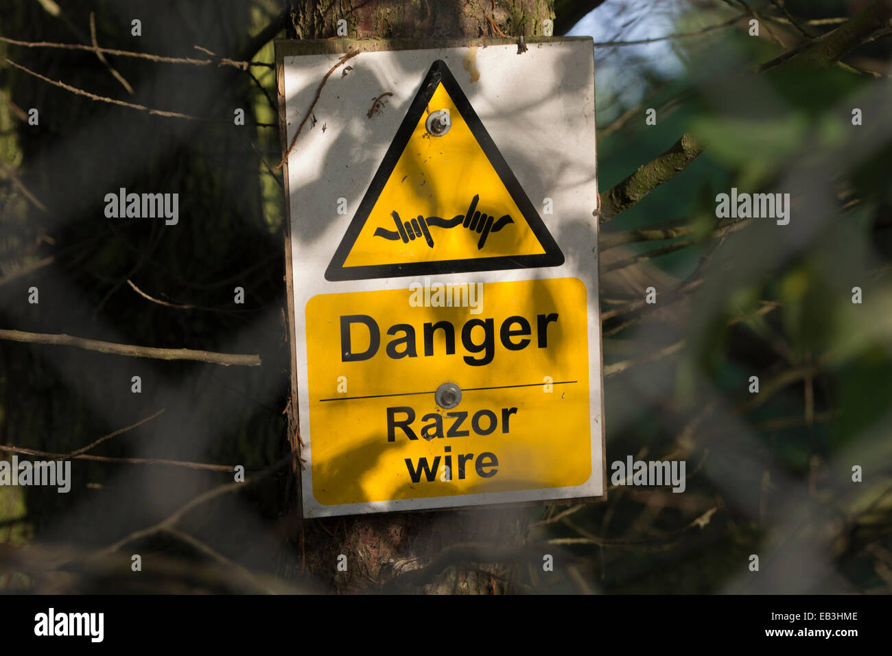 Danger razor wire sign Stock Photo - Alamy