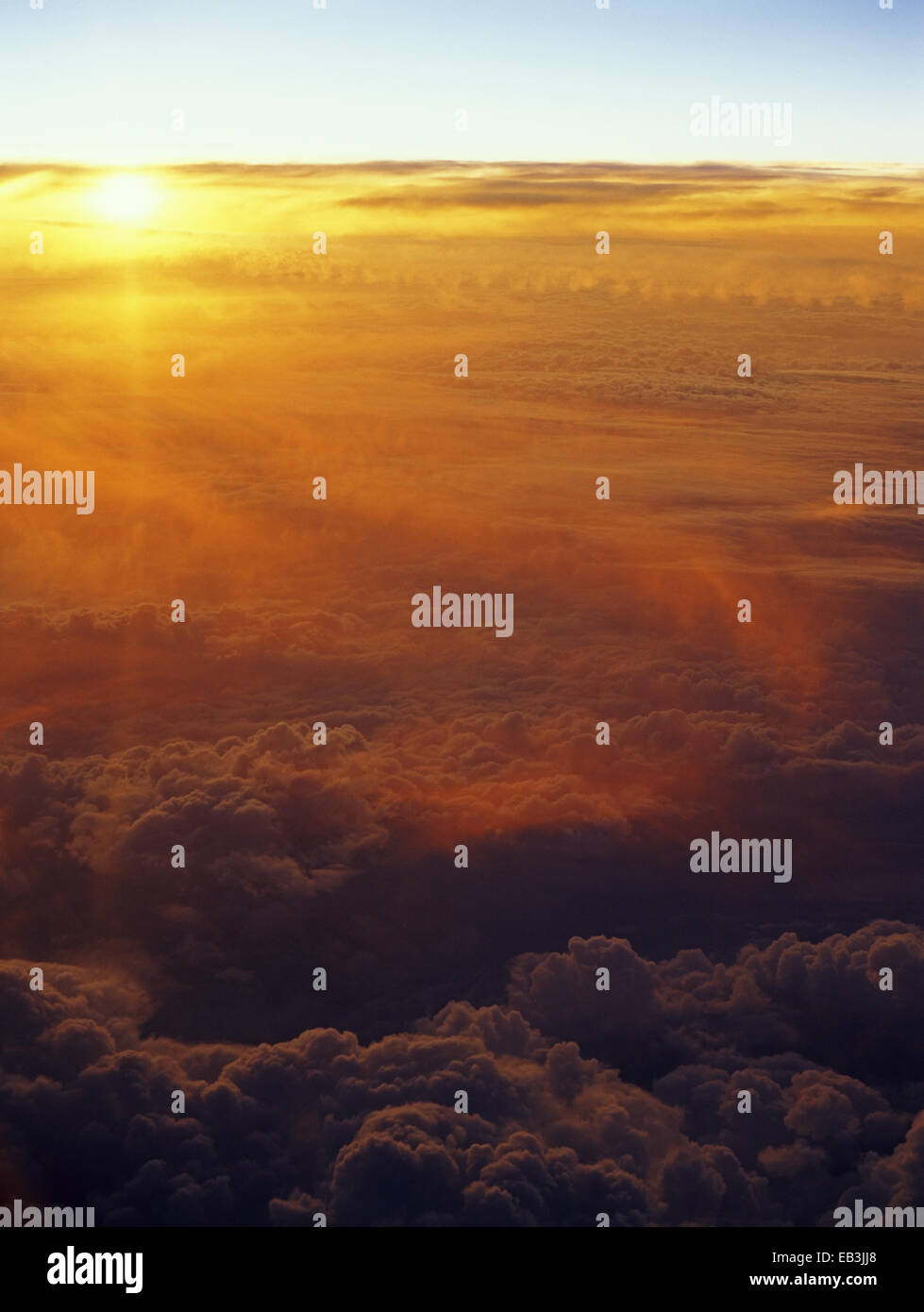 Sunset over a clouds Stock Photo - Alamy