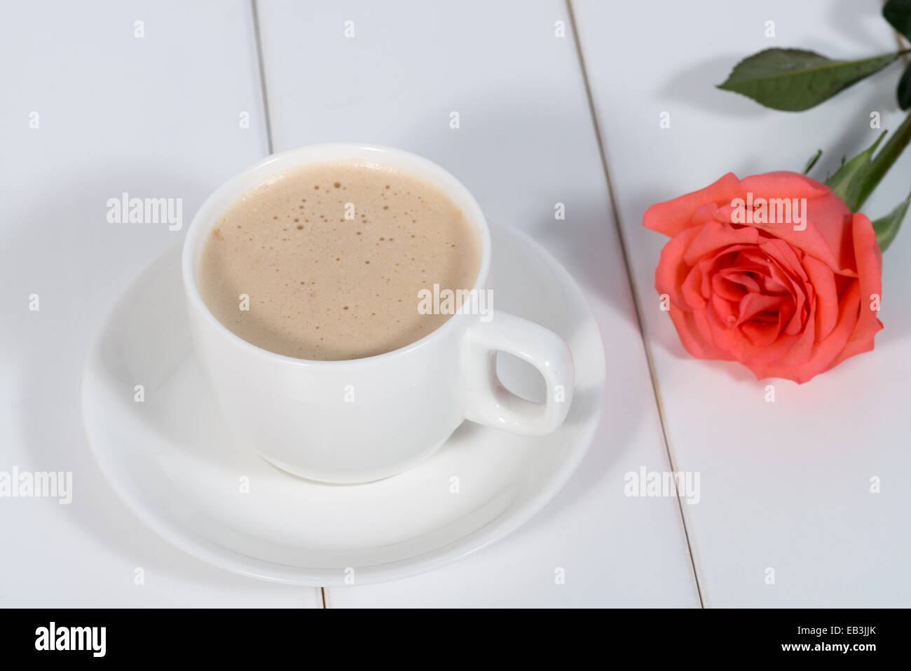 Cups of coffee and pink roses on white background Stock Photo - Alamy