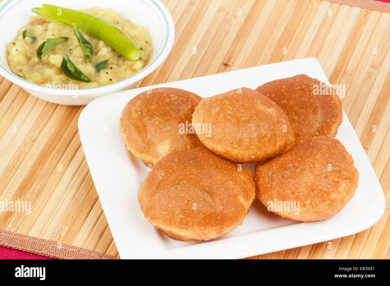 Delicious deep fried poori (puri) served with spicy potato onion curry ...