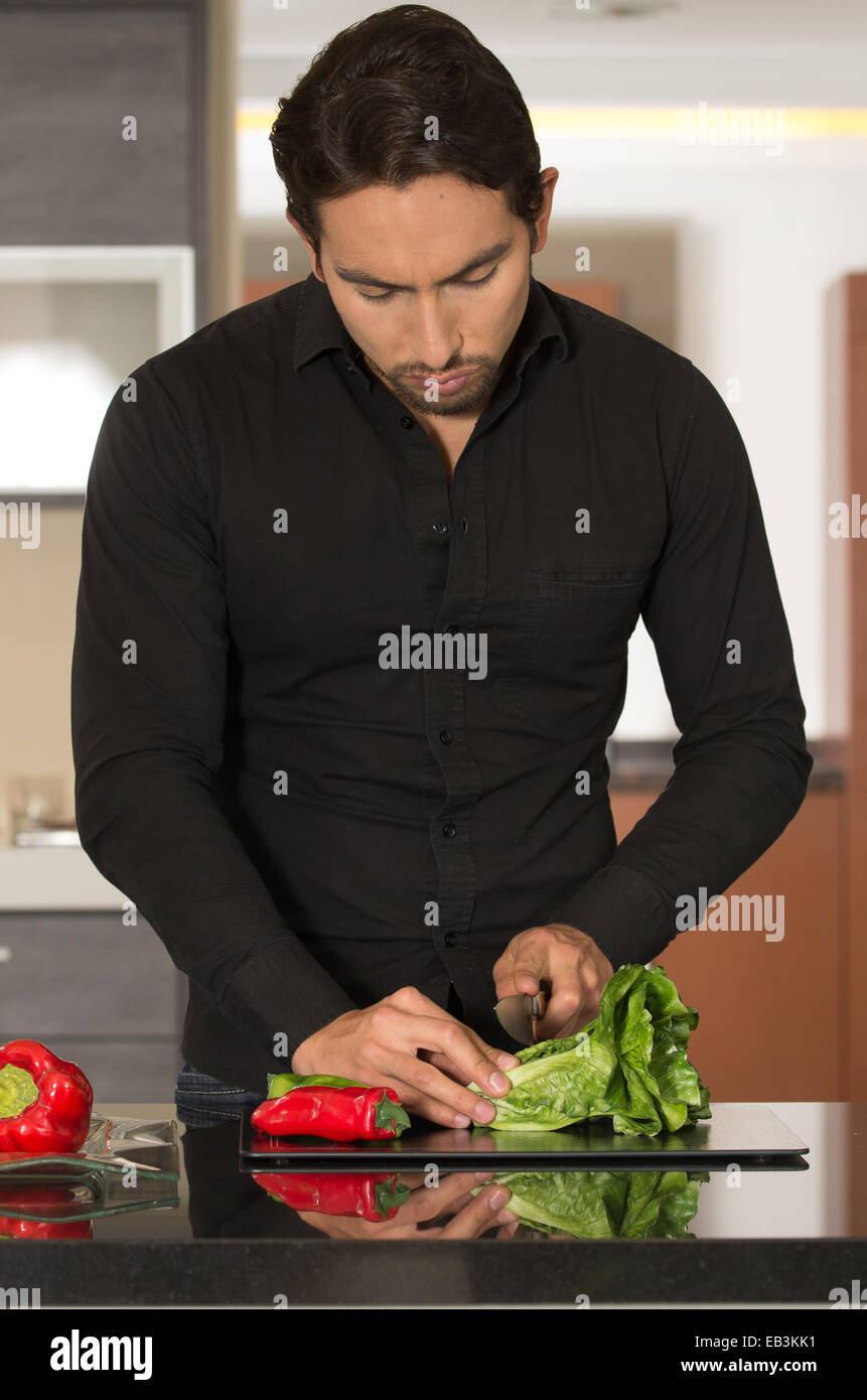 handsome young man cooking in modern kitchen Stock Photo - Alamy