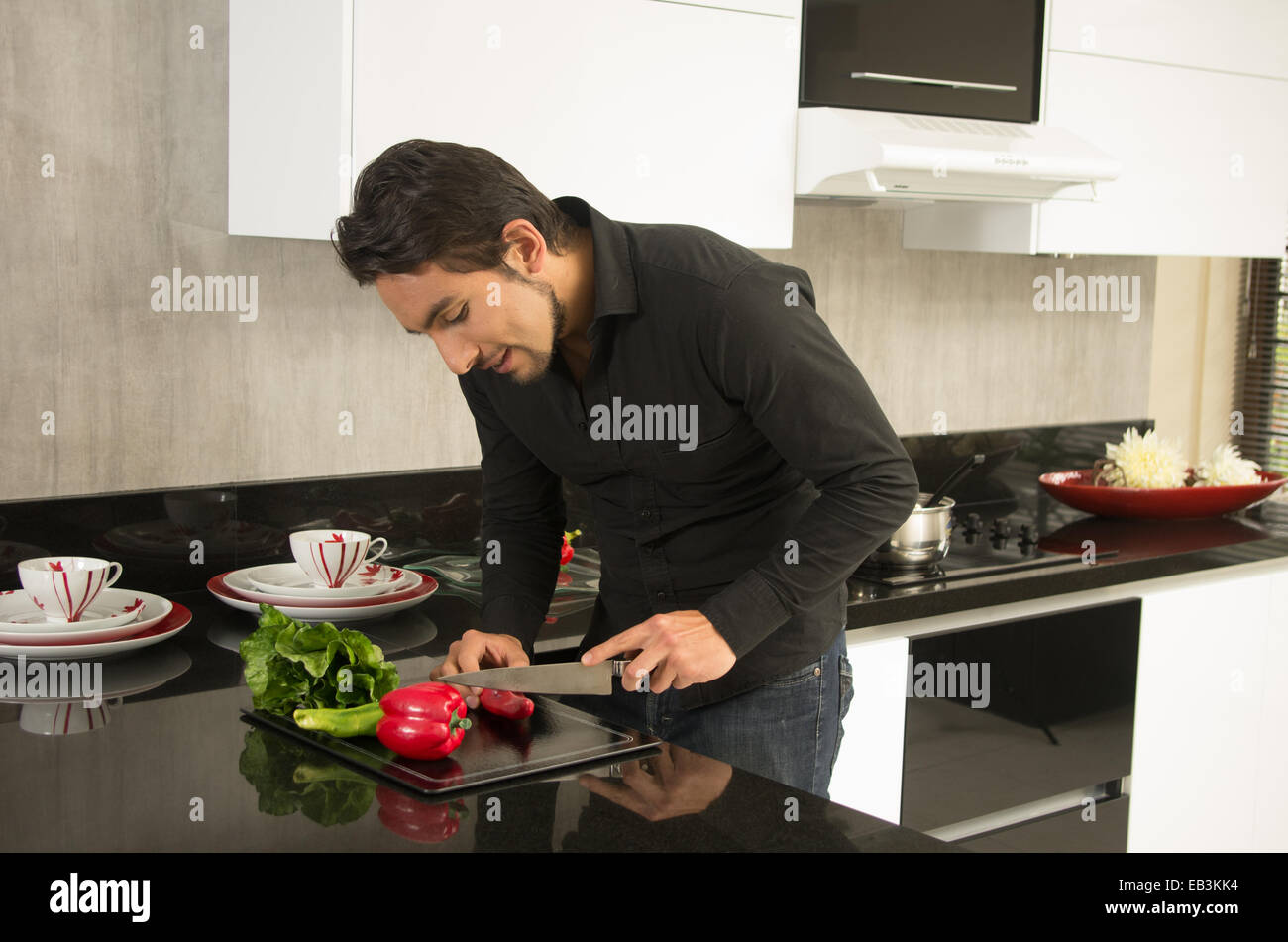 handsome young man cooking in modern kitchen Stock Photo - Alamy