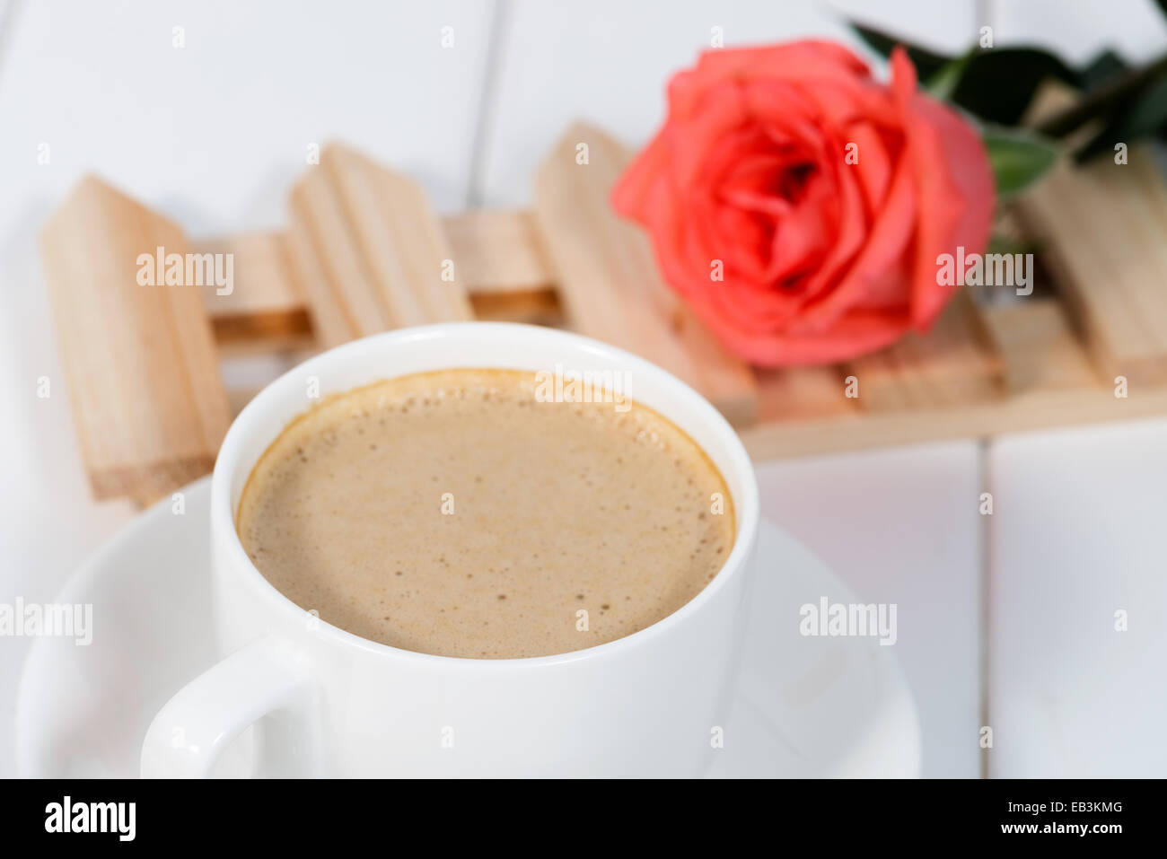 Cups of coffee and pink roses on white background Stock Photo - Alamy