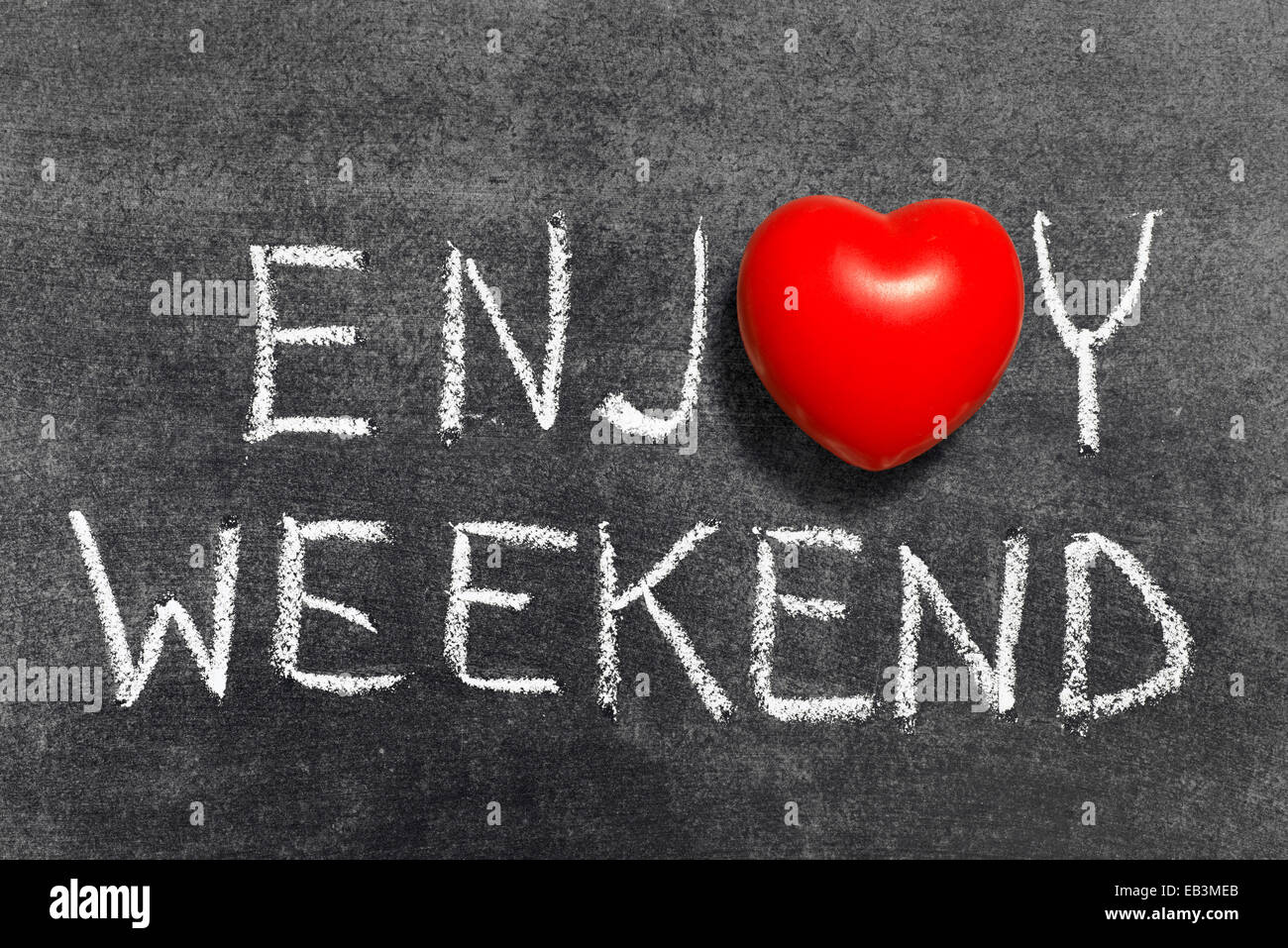 enjoy weekend phrase handwritten on blackboard with heart symbol ...