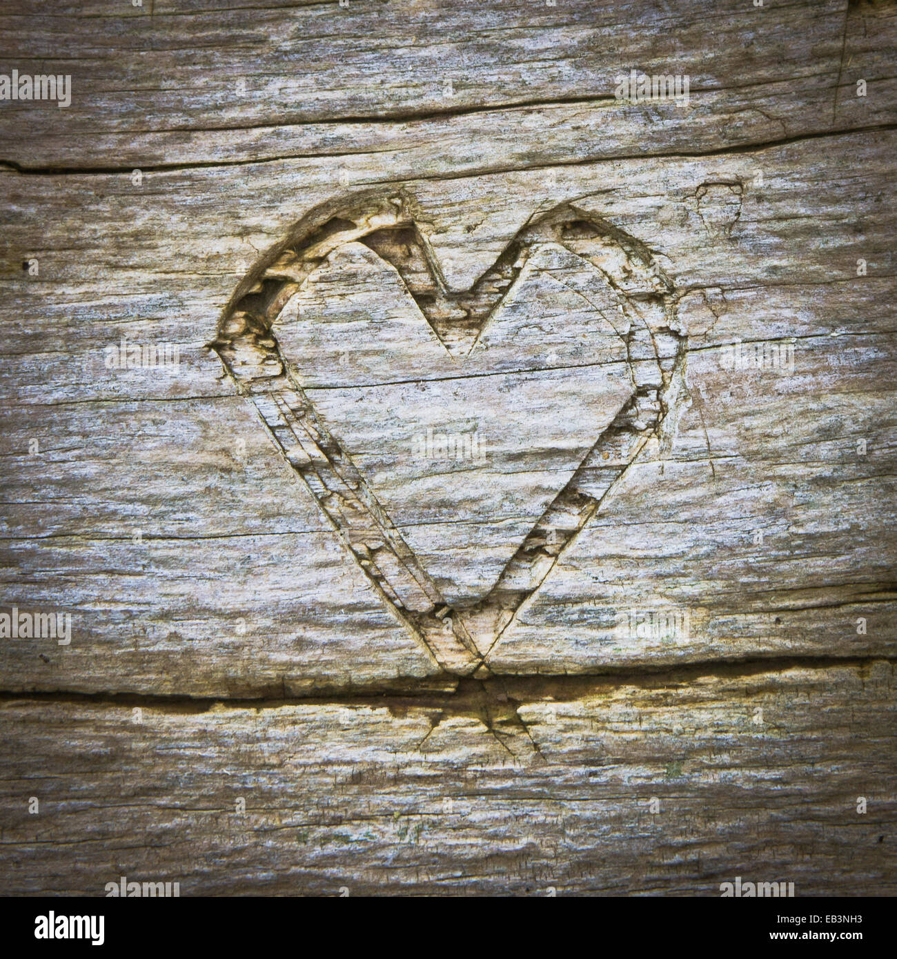 Heart shape carved into wood Stock Photo - Alamy