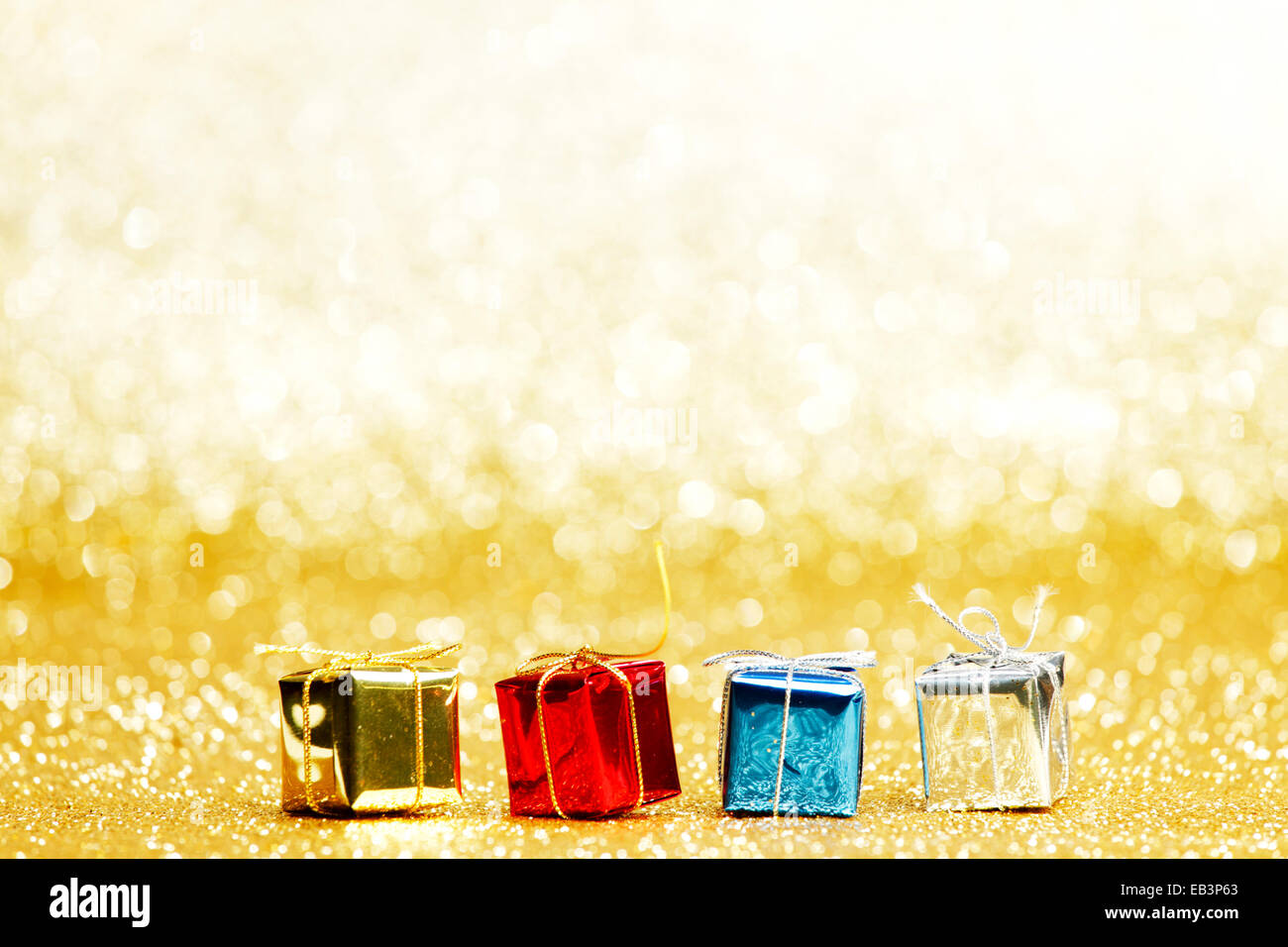 Small decorative colorful presents on glitter background Stock Photo ...