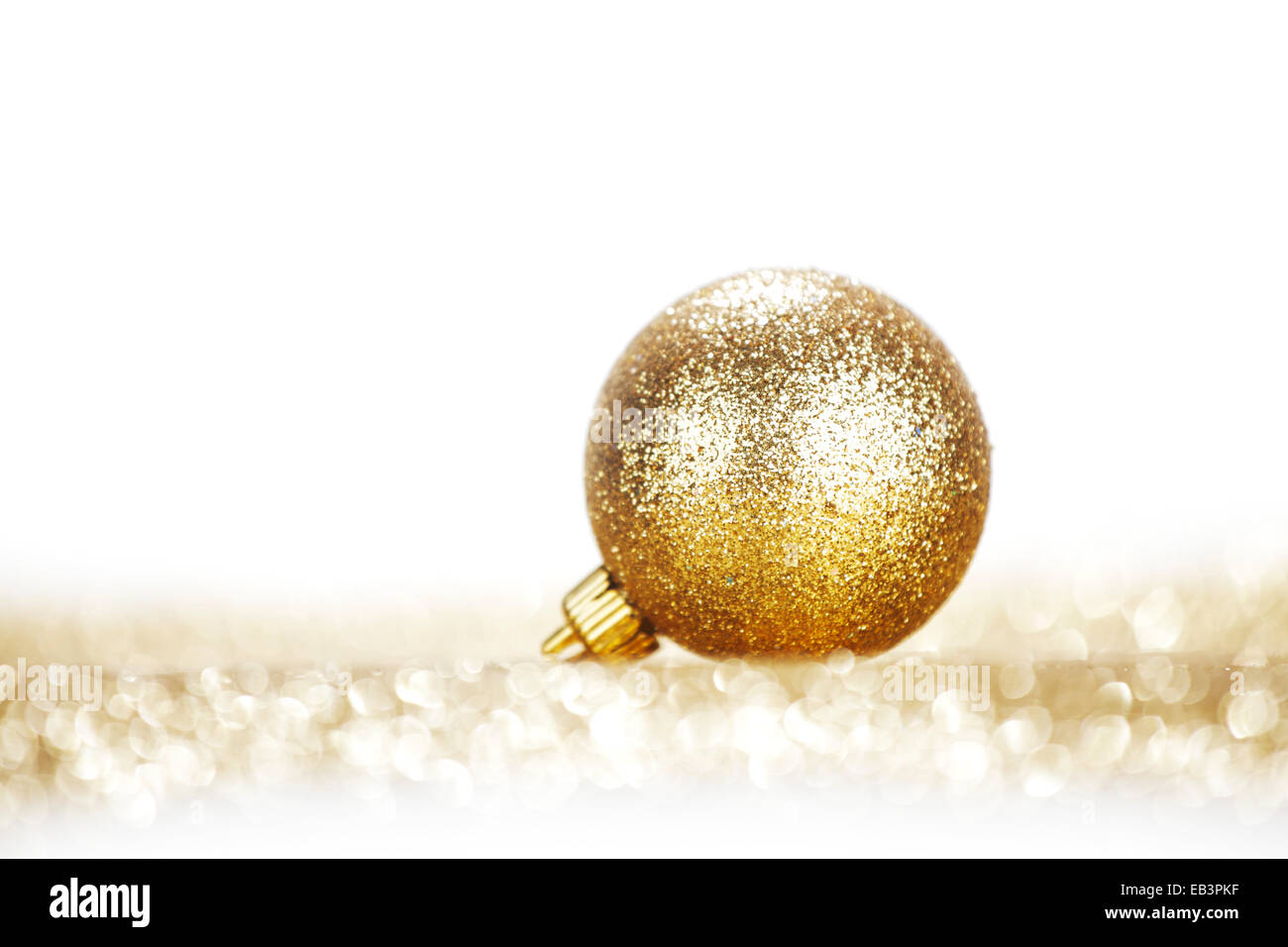 One chritmas ball on glitters isolated on white background Stock Photo ...
