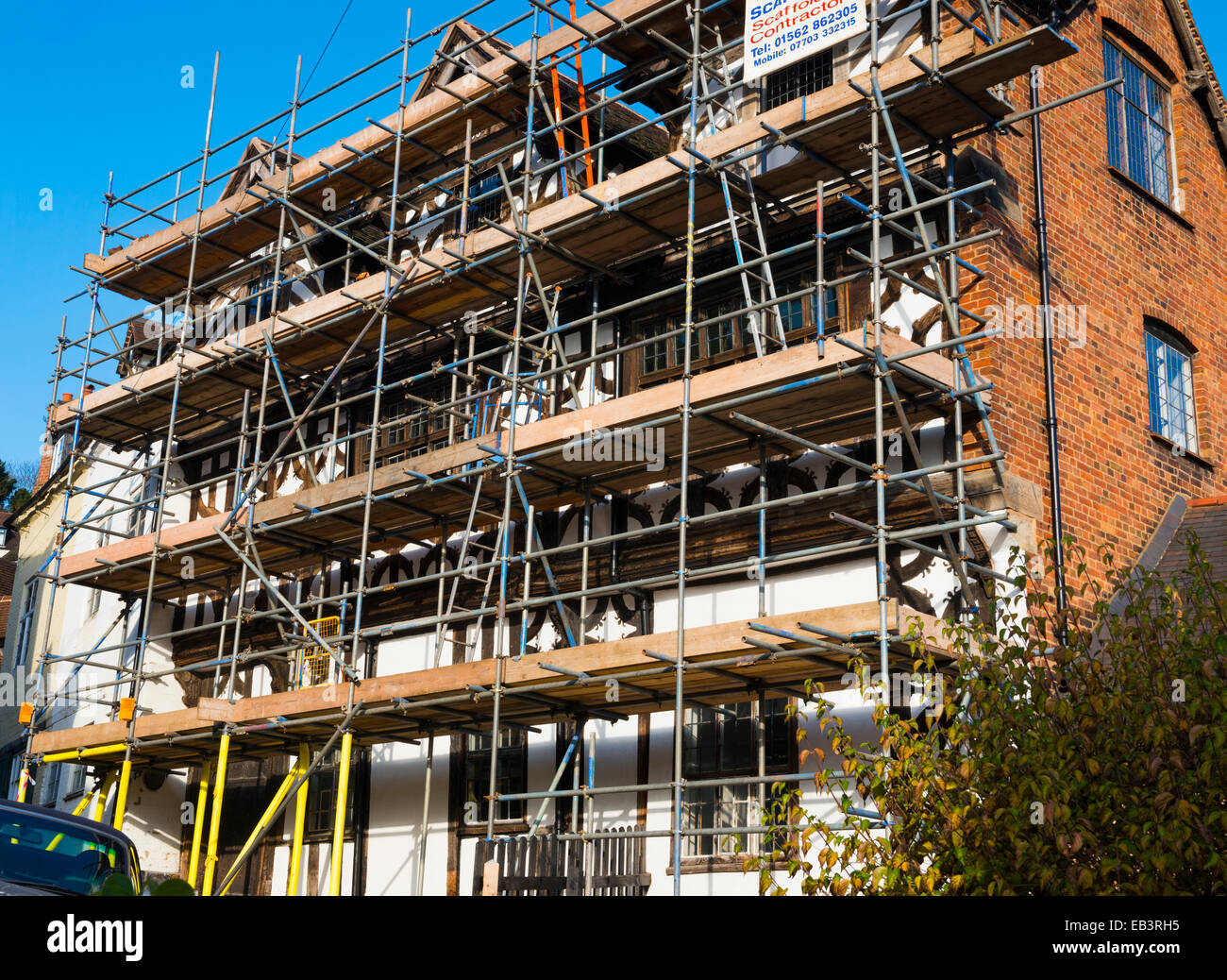 A half-timbered building covered in scaffolding in Bridgnorth ...