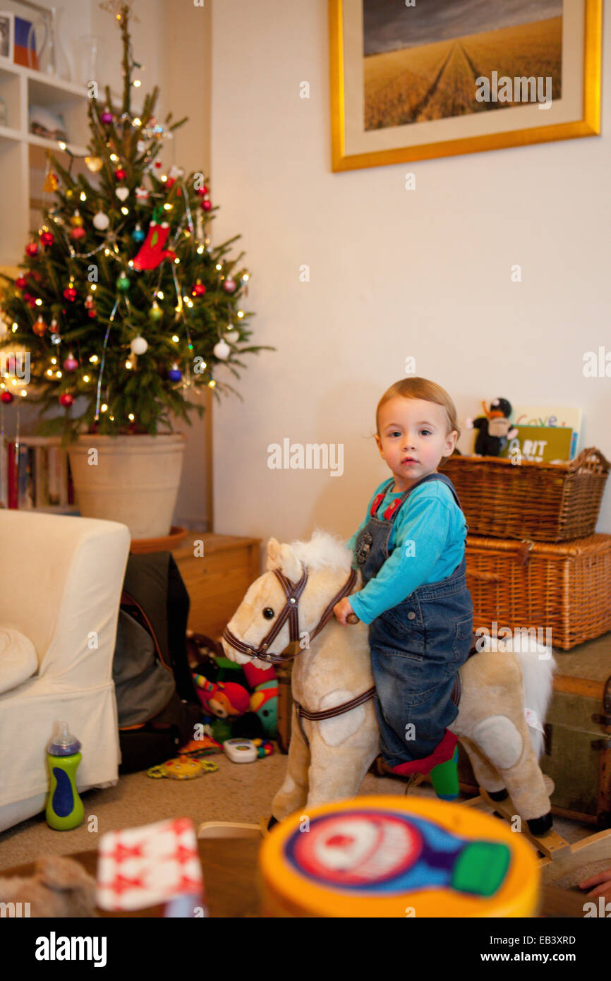 Toddler on rocking horse Stock Photo - Alamy