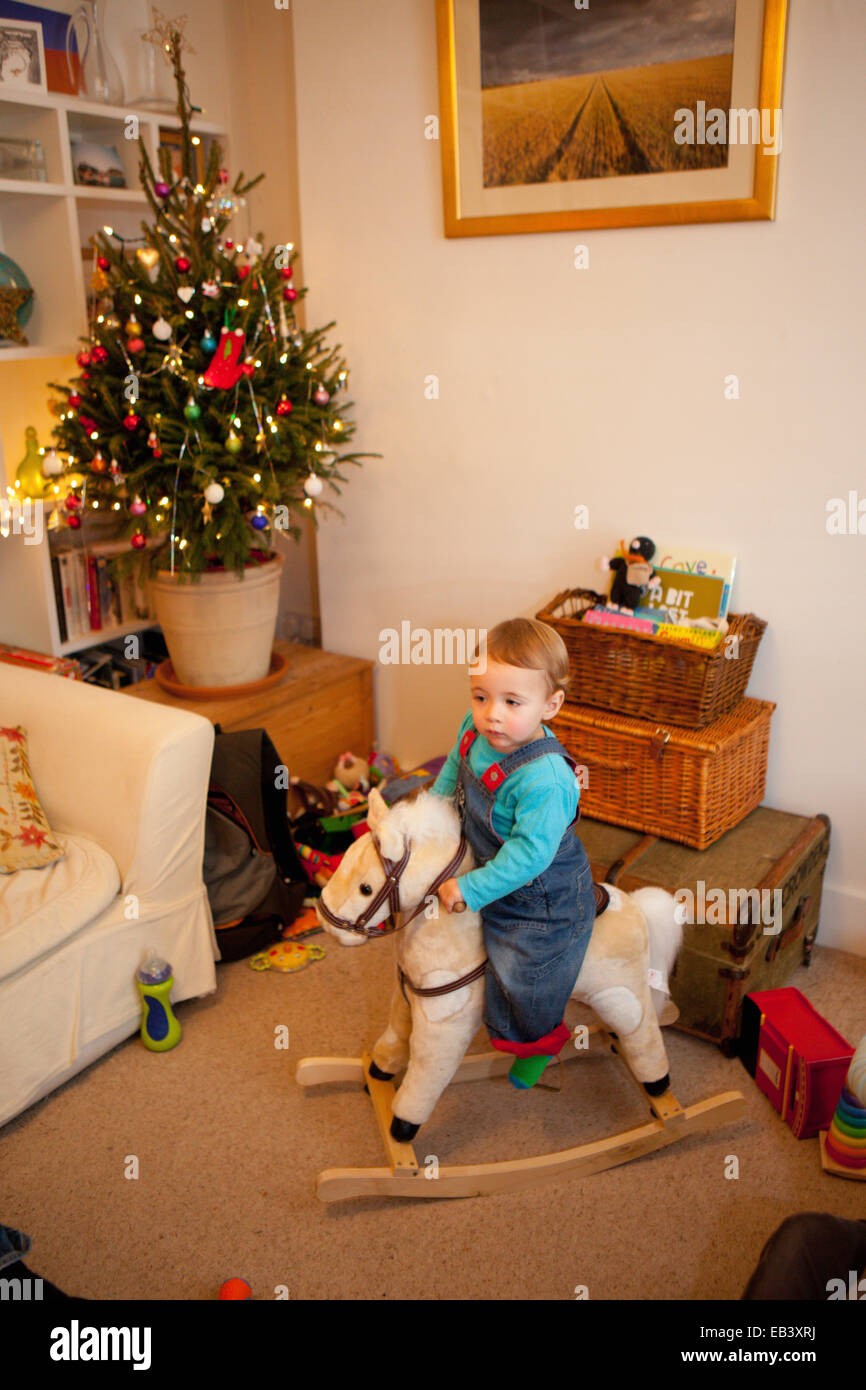 Toddler on rocking horse Stock Photo - Alamy