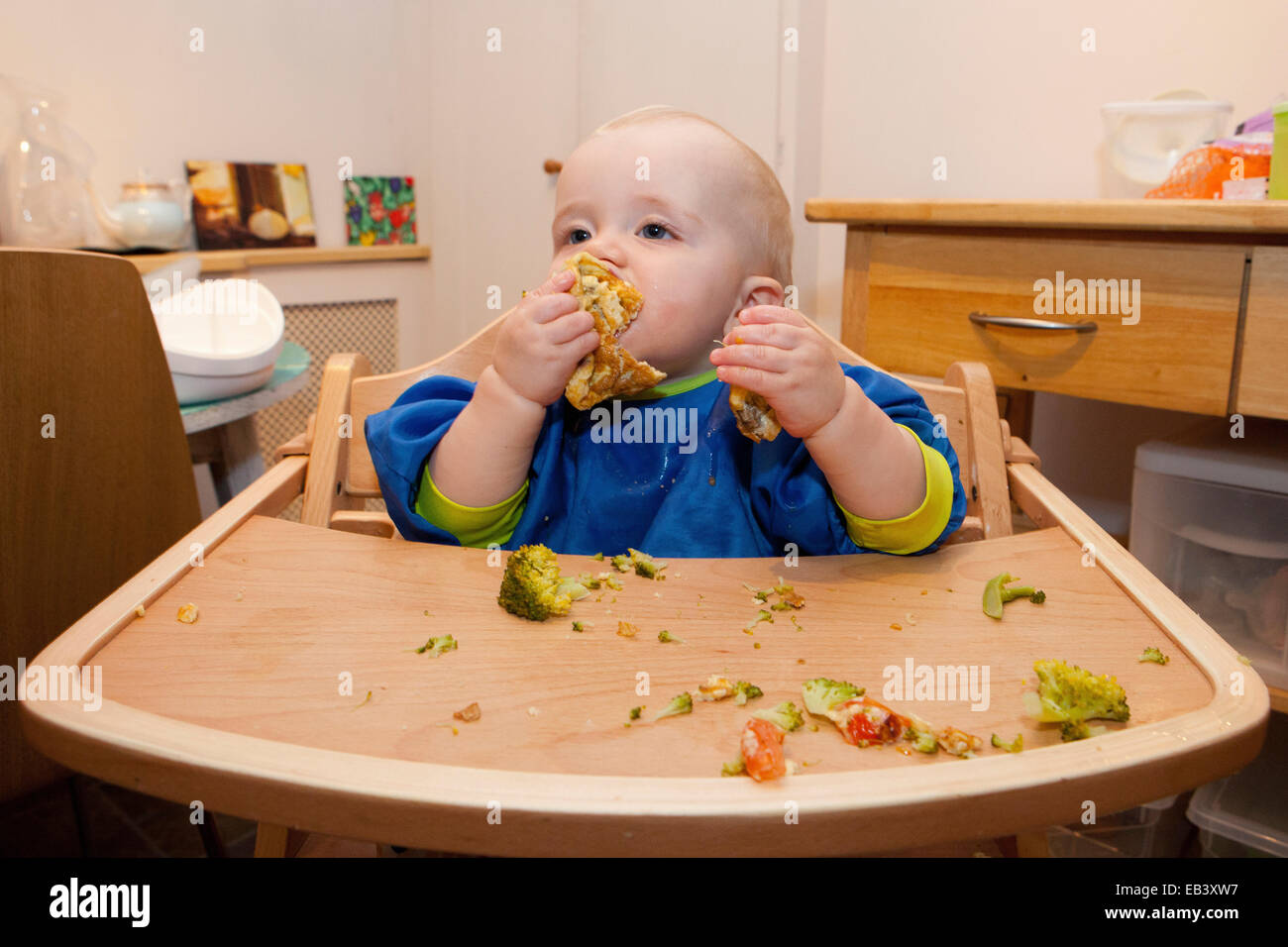Baby holding food messy hi-res stock photography and images - Alamy