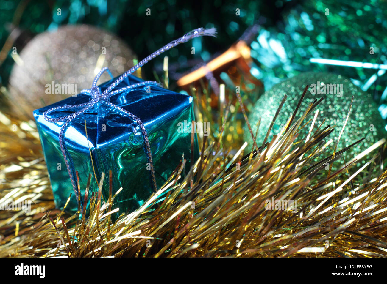 Bright blue Christmas box against multi coloured ornament Stock Photo ...