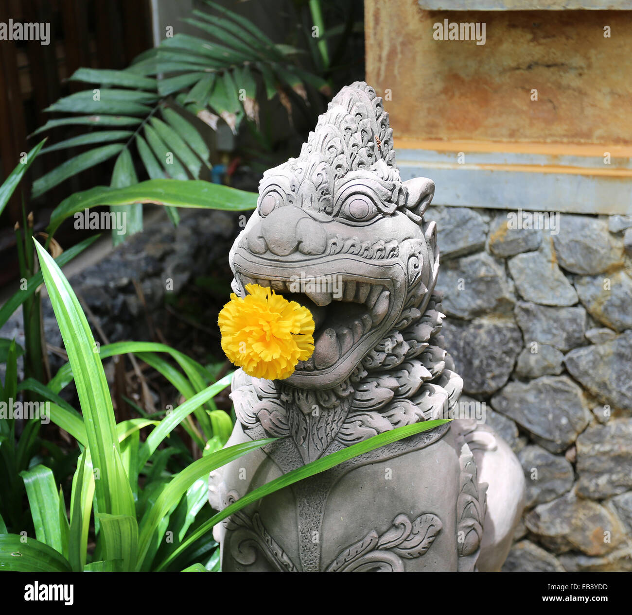 beautiful sculpture of the deity monster with a flower in the garden ...