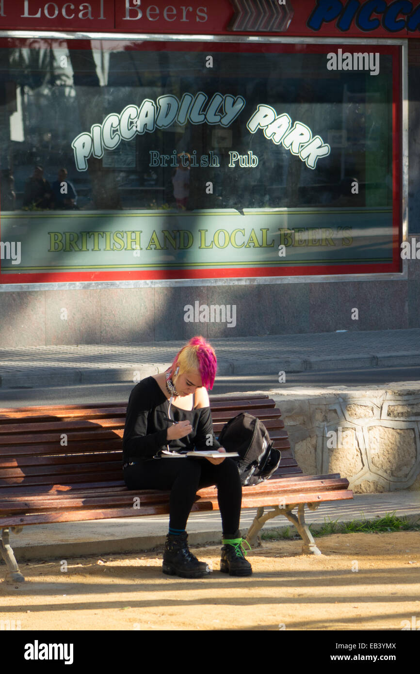 Benidorm, Costa Blanca, Spain, Europe. Punk on bench with purple hair ...