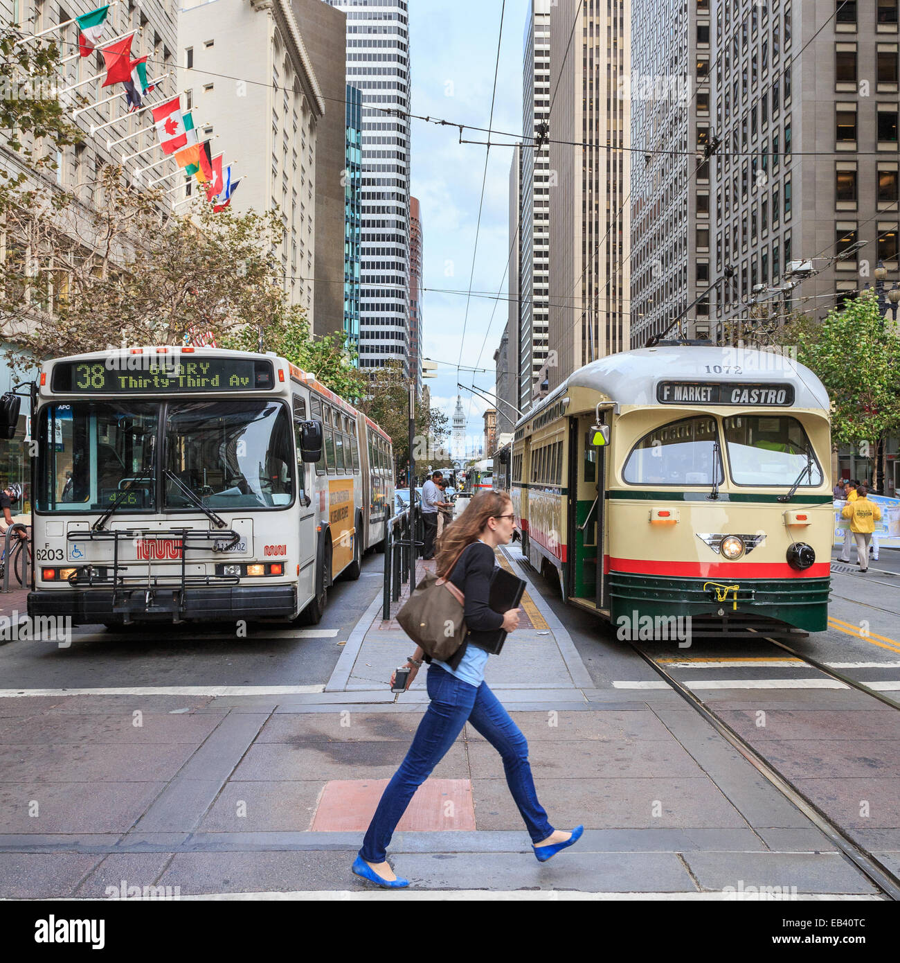 SAN FRANCISCO, CA, USA - OCTOBER 15, 2014: Young woman hurries across ...