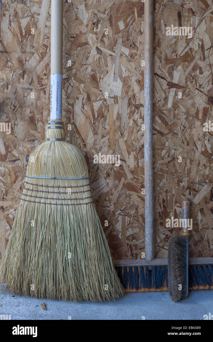 Three brooms. A corn broom, a push broom and a hand broom Stock Photo ...