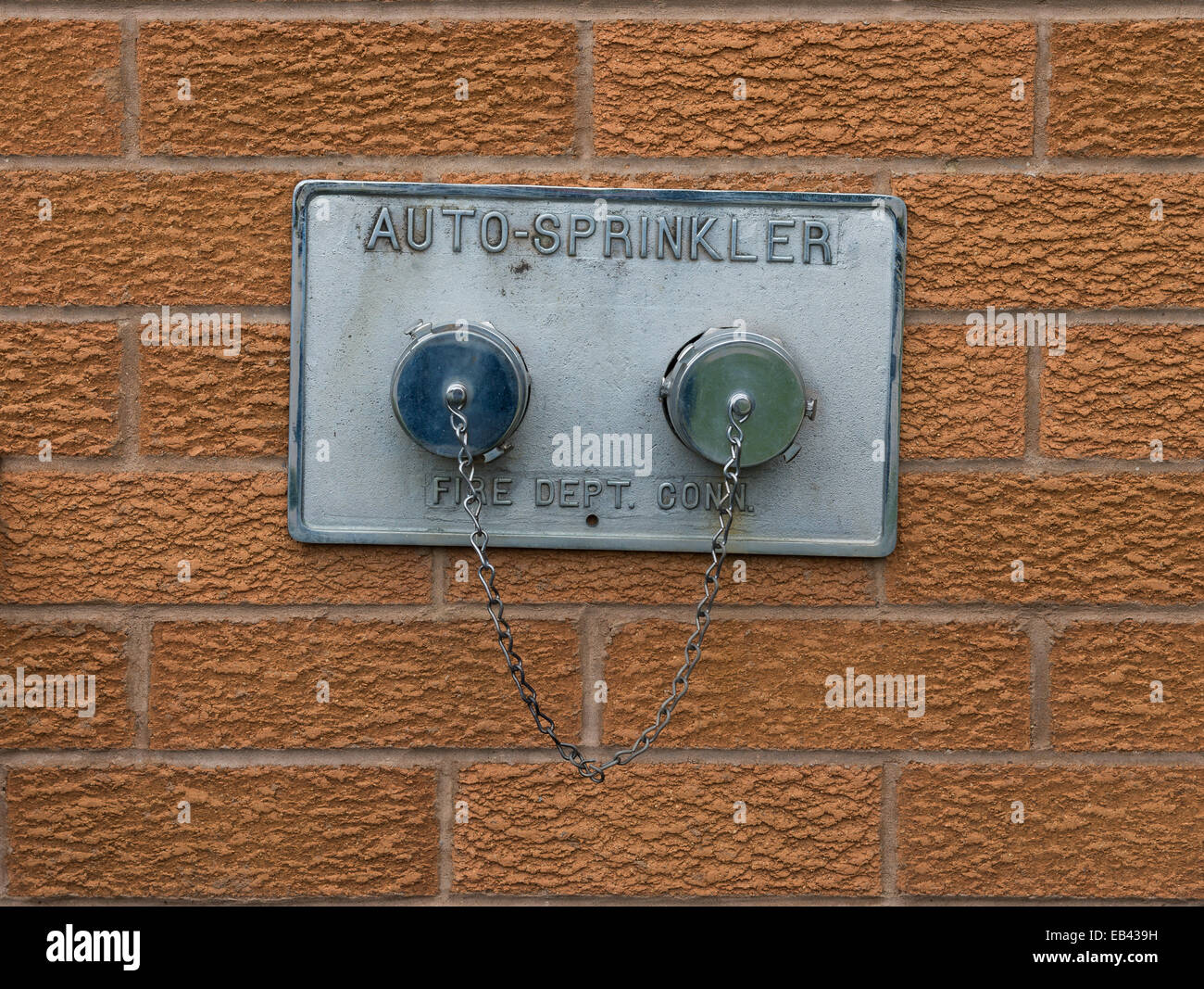 A fire department water outlet on the outside of a building Stock Photo ...