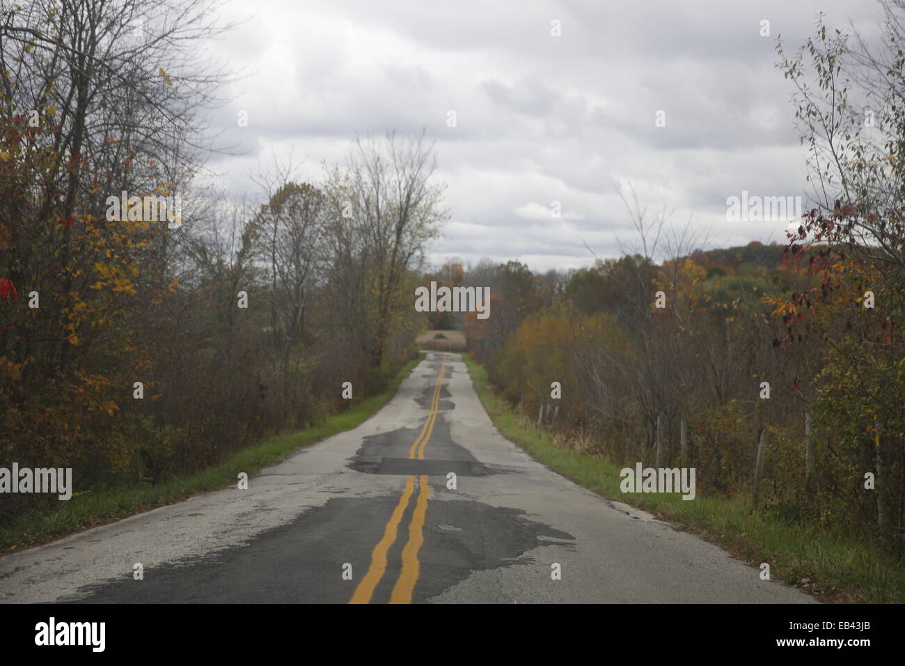 Rural Indiana road trip with autumn leaves and yellow line. scenic ...