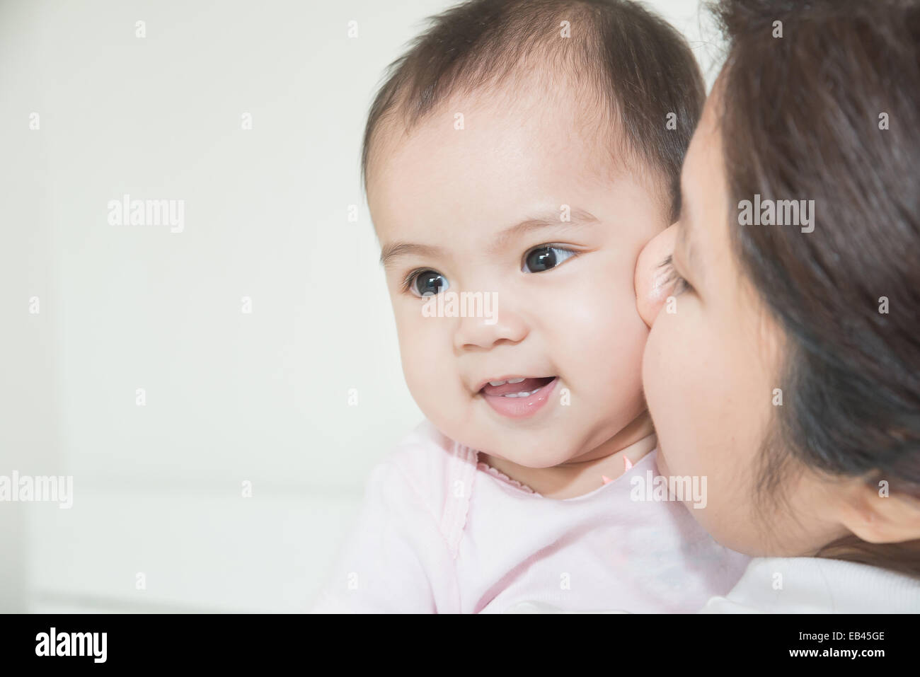 Asian daughter hugging kissing mother hi-res stock photography and images - Alamy