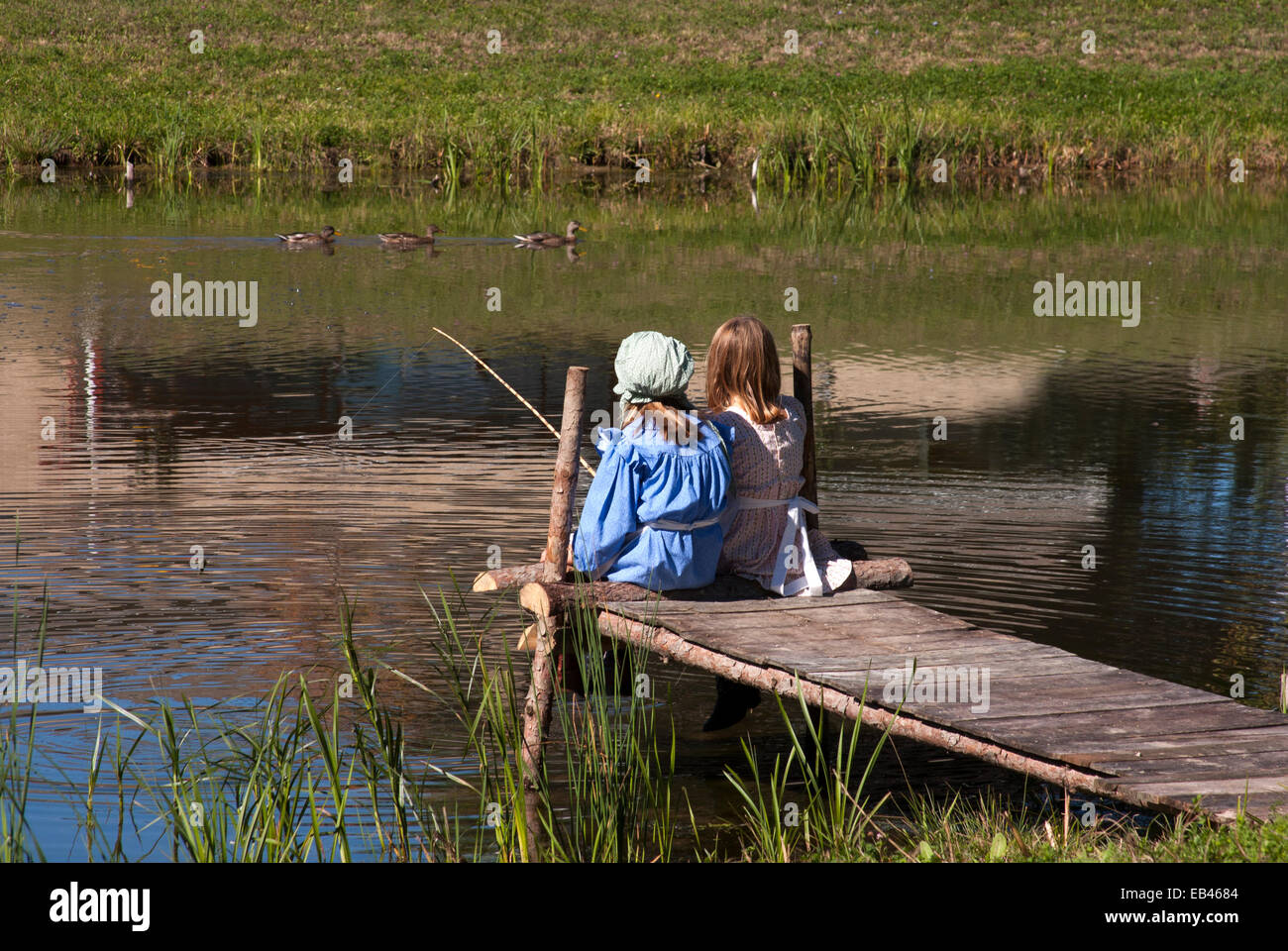 Two country girls fishing on a local pond Stock Photo - Alamy