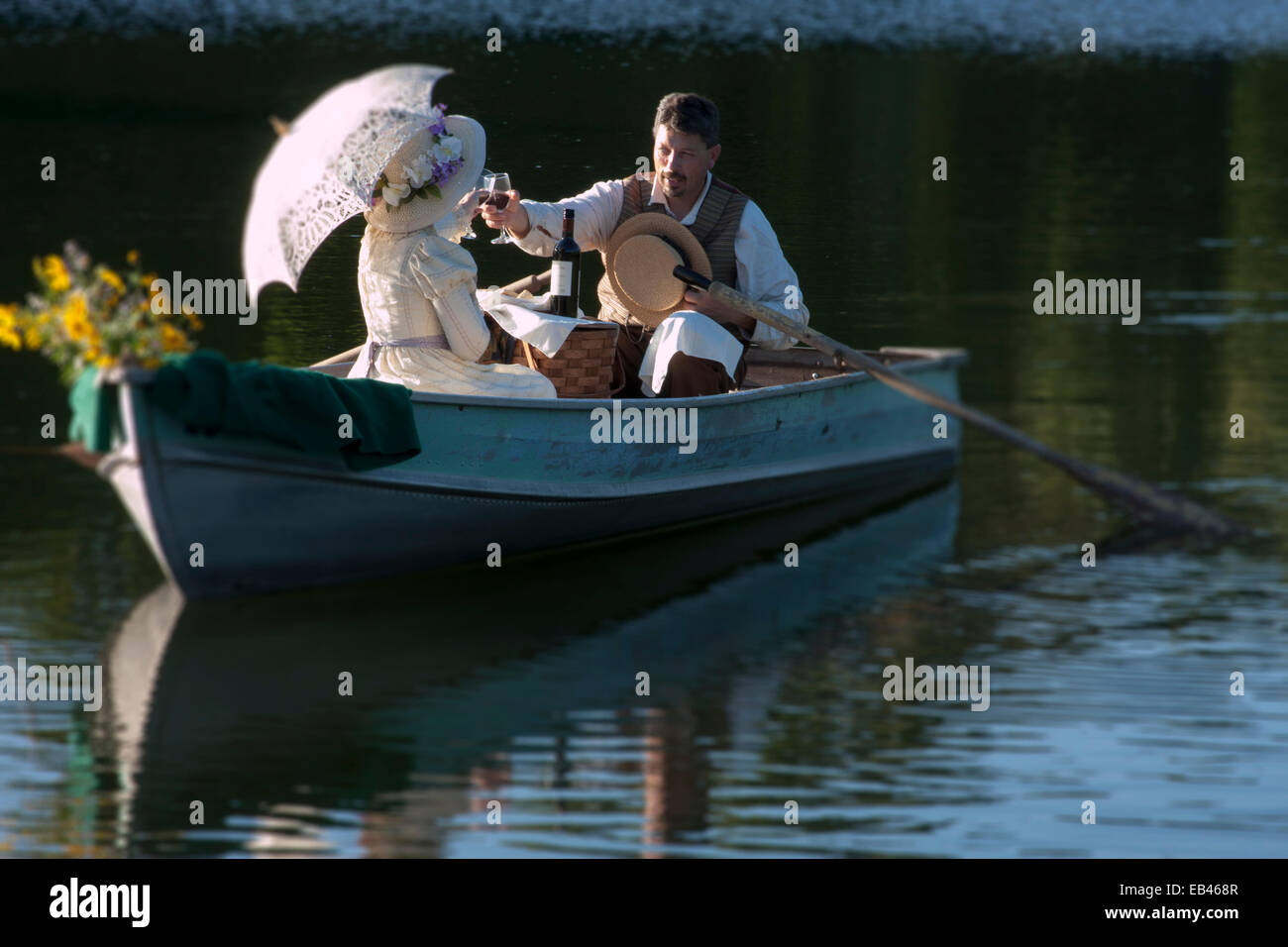 A romantic Victorian couple enjoying a bottle of wine in a rowboat ...