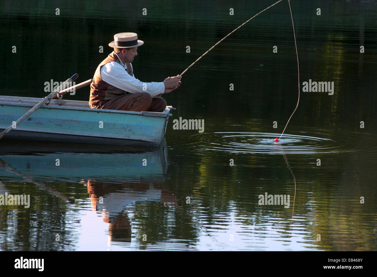 A Victorian dressed man fishing Stock Photo - Alamy