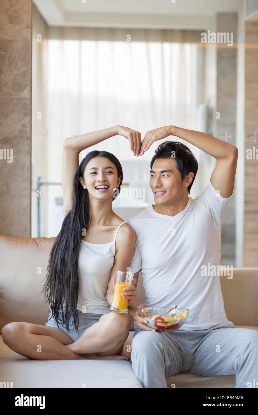 Young couple making heart shape with their arms Stock Photo - Alamy