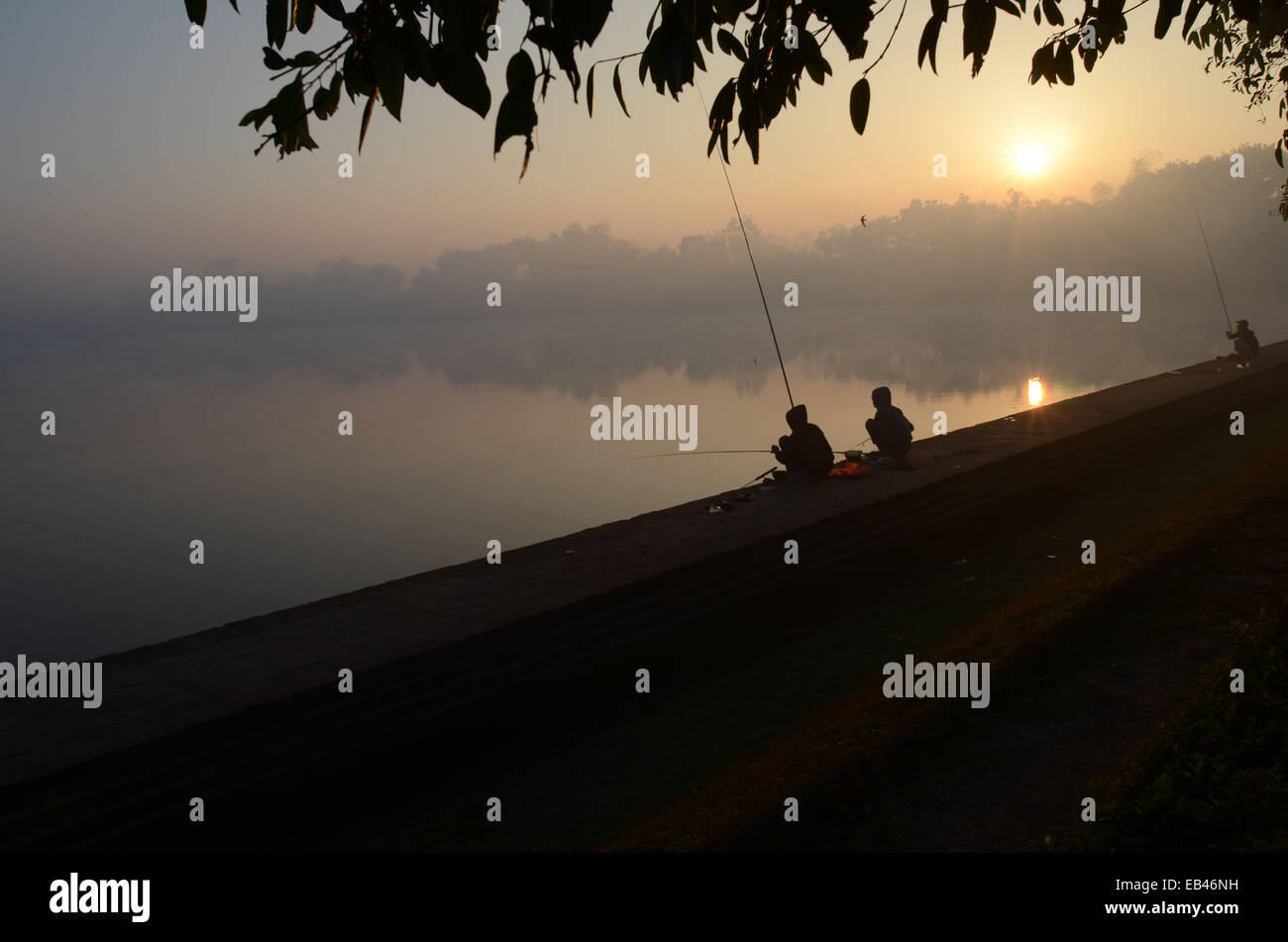 Residents fishing at Segaran pool in the village of Trowulan. An area ...