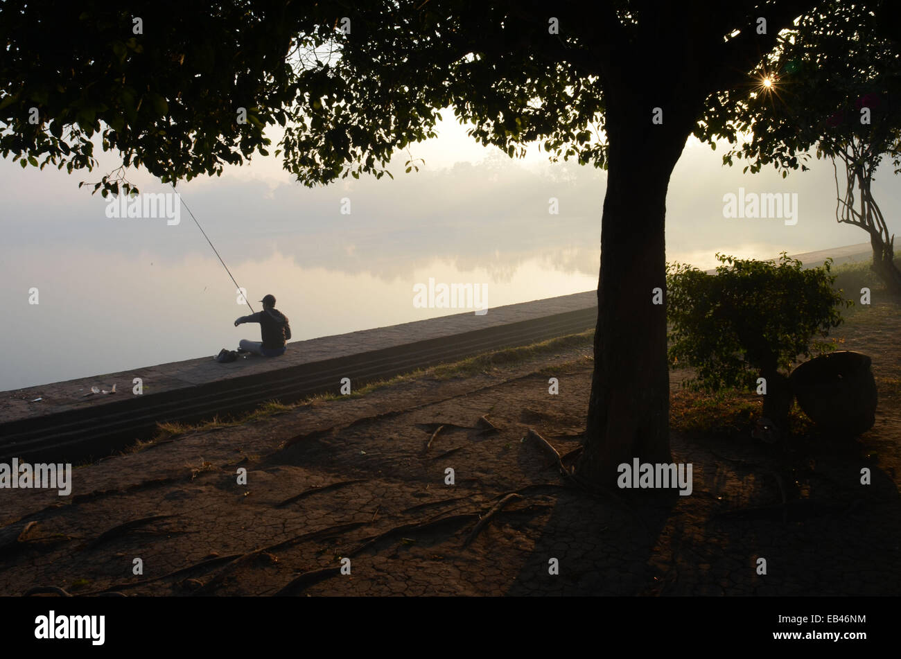 A resident fishing at Segaran pool in the village of Trowulan. An area ...