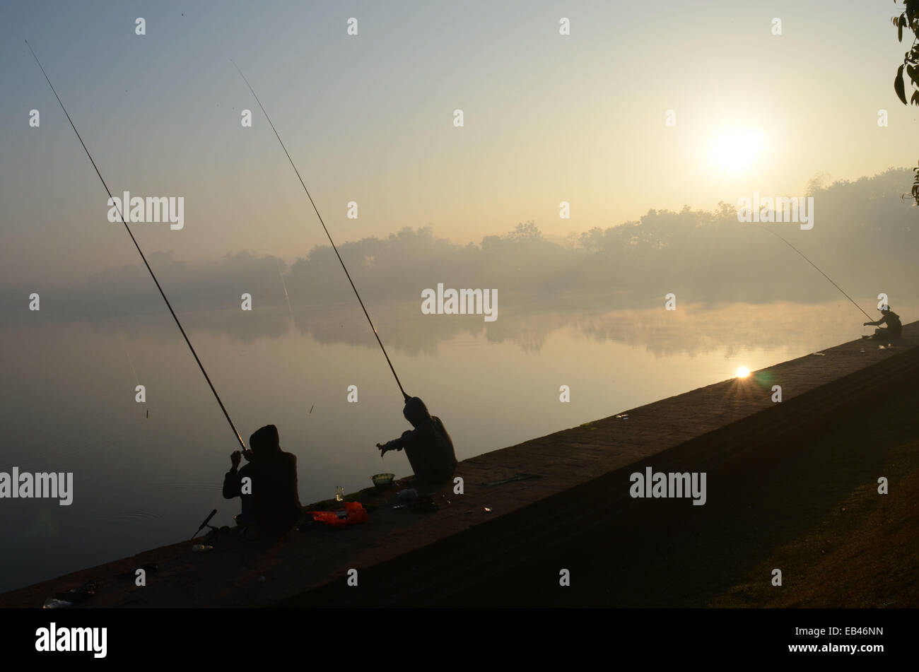 Residents fishing at Segaran pool in the village of Trowulan. An area ...