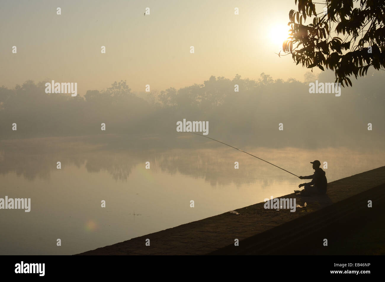 A resident fishing at Segaran pool in the village of Trowulan. An area ...