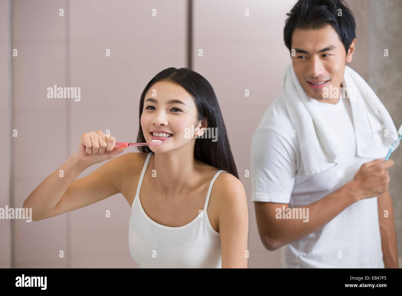Young couple brushing teeth together Stock Photo - Alamy