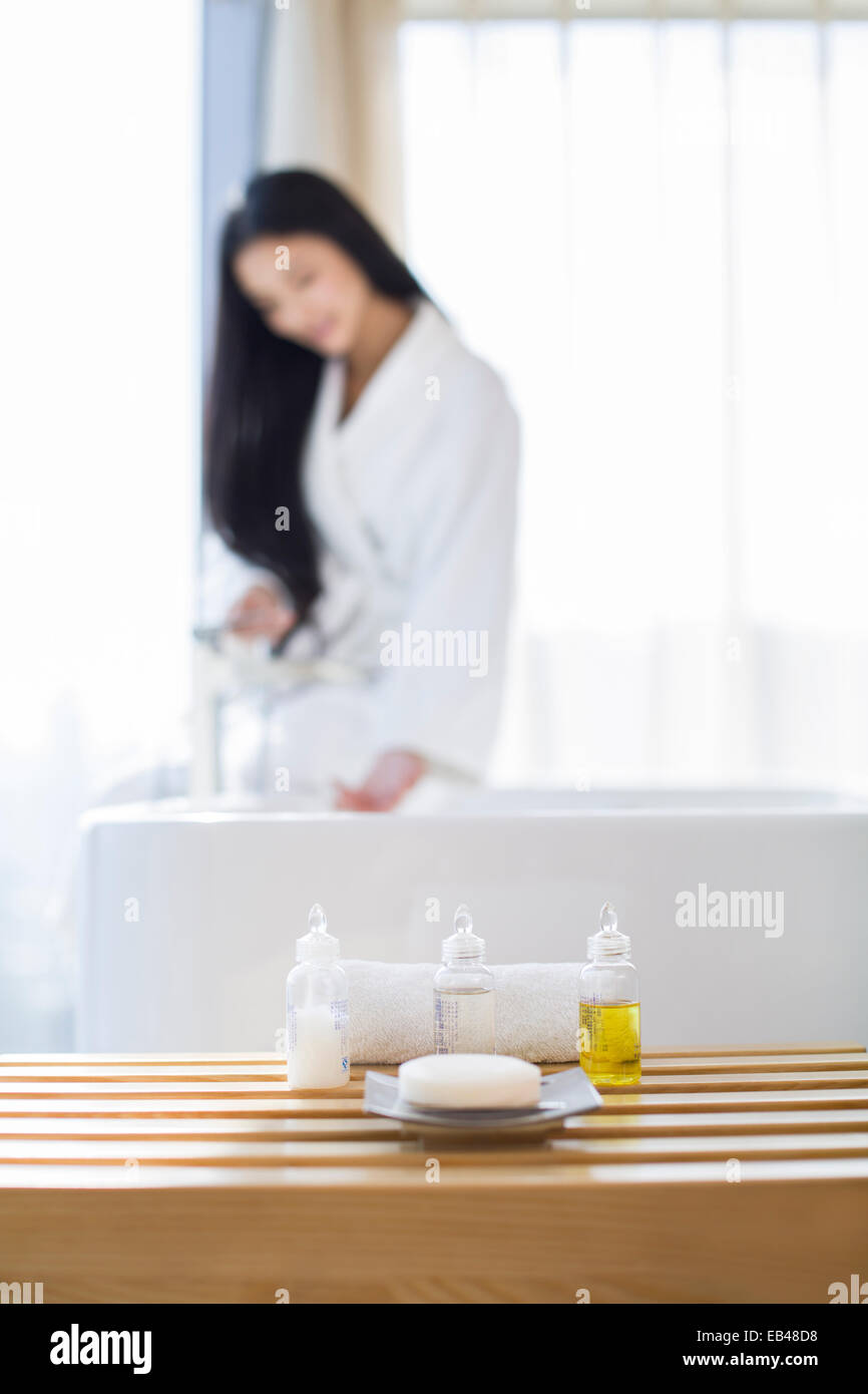 Young woman filling bathtub Stock Photo - Alamy