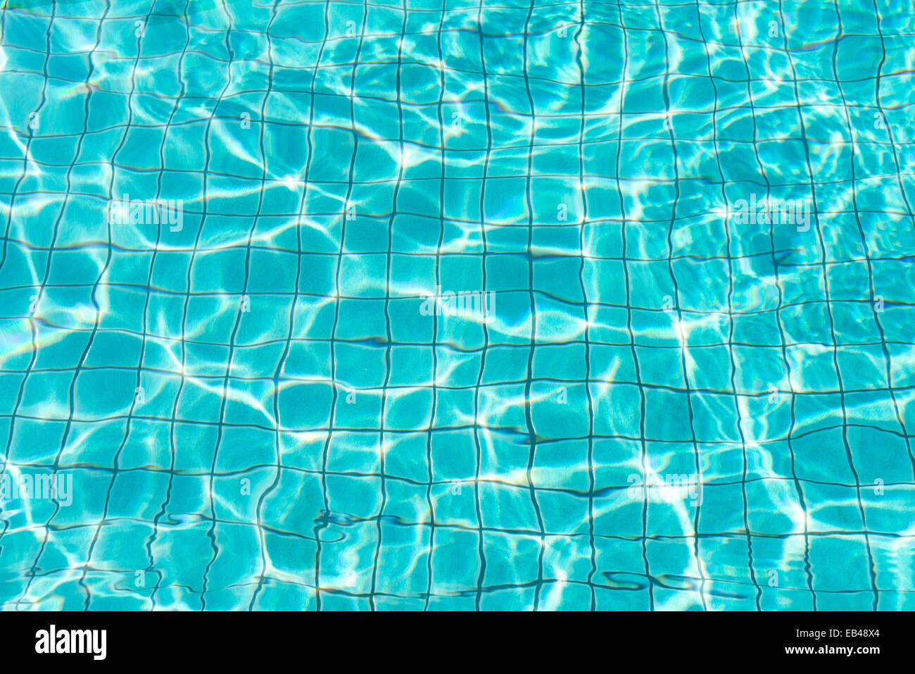 Blue pool water with sun reflections Stock Photo - Alamy