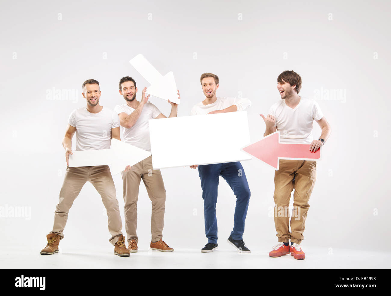 Group of joyful guys holding white symbols Stock Photo - Alamy