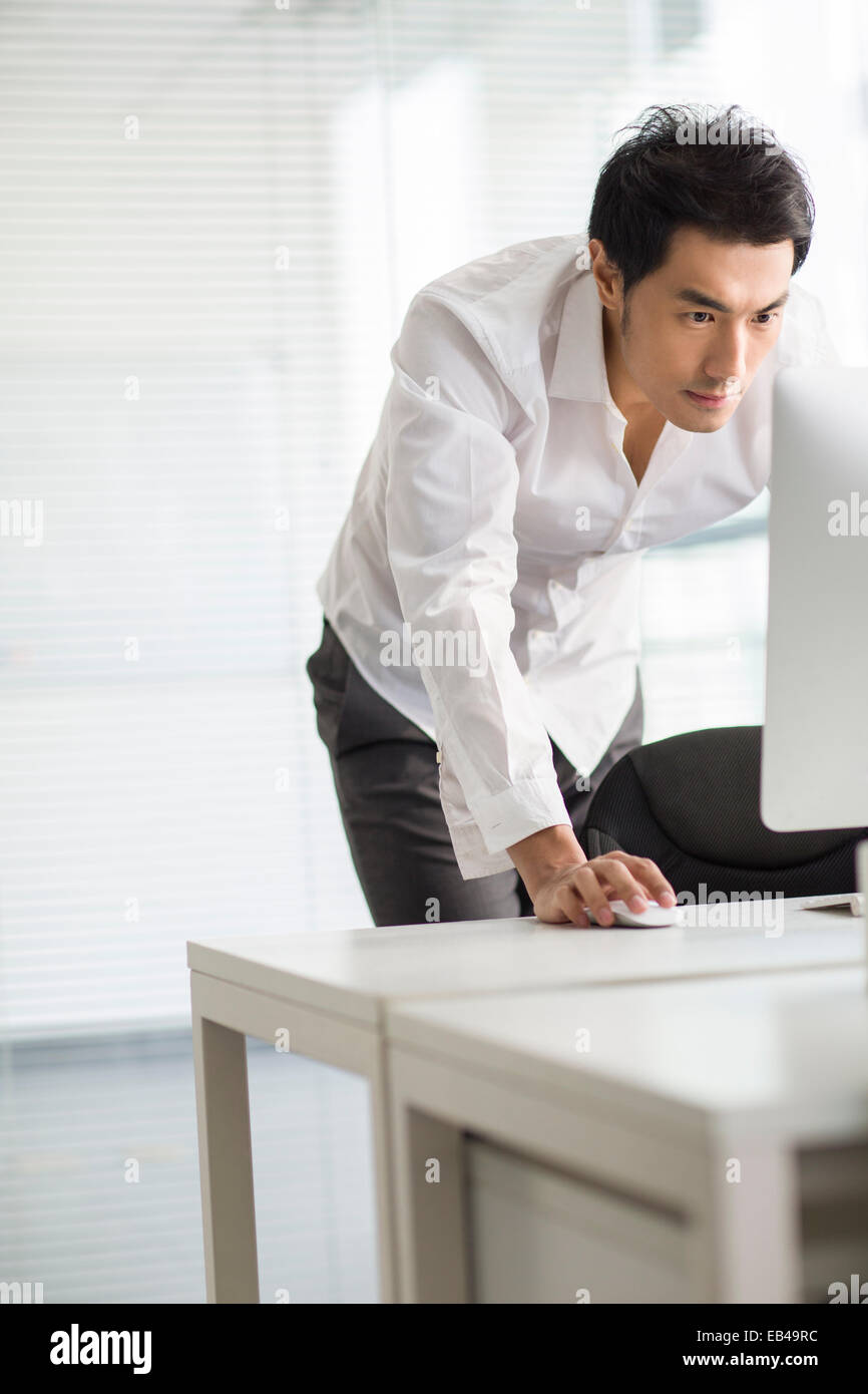 Young businessman using computer in office Stock Photo - Alamy