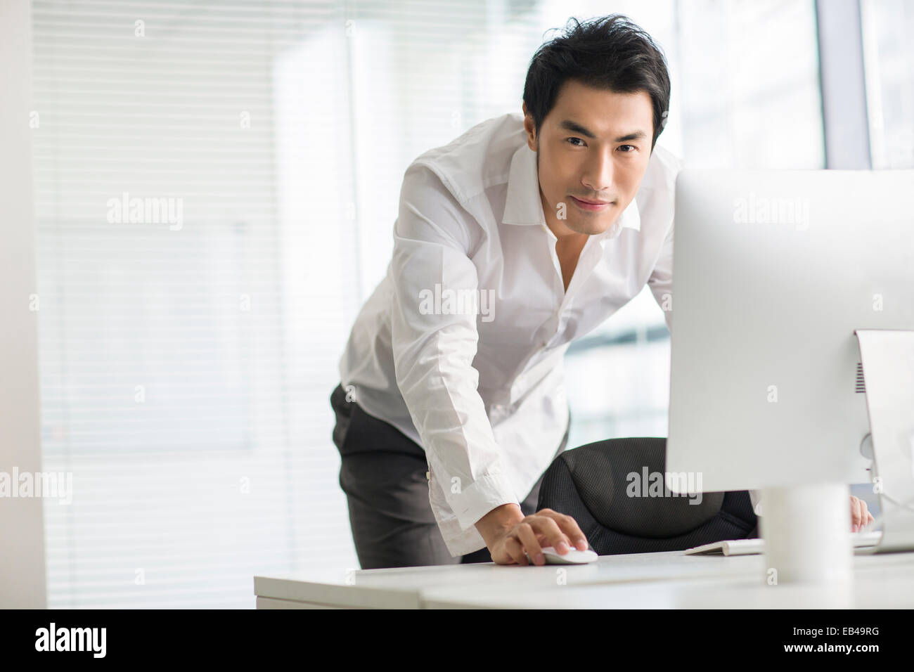Young businessman using computer in office Stock Photo - Alamy